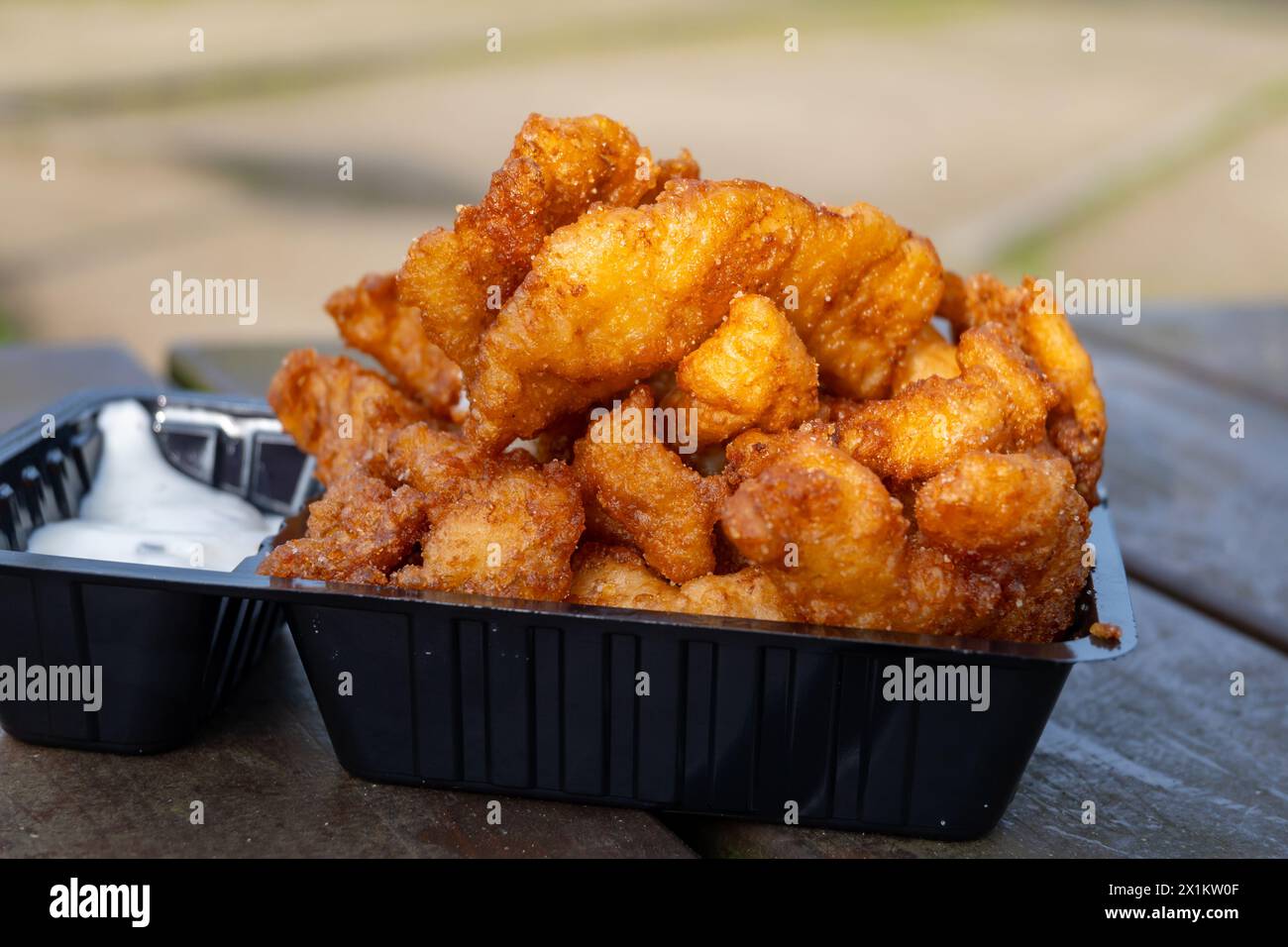 Seafood, outdoor eating of diep-fried cod fish pieces served with ...