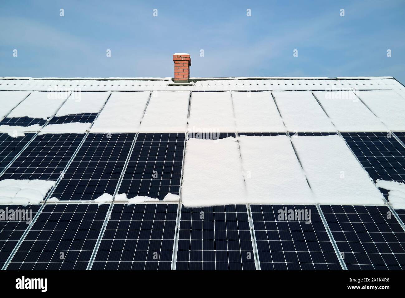 Aerial view of snow melting from covered solar photovoltaic panels ...