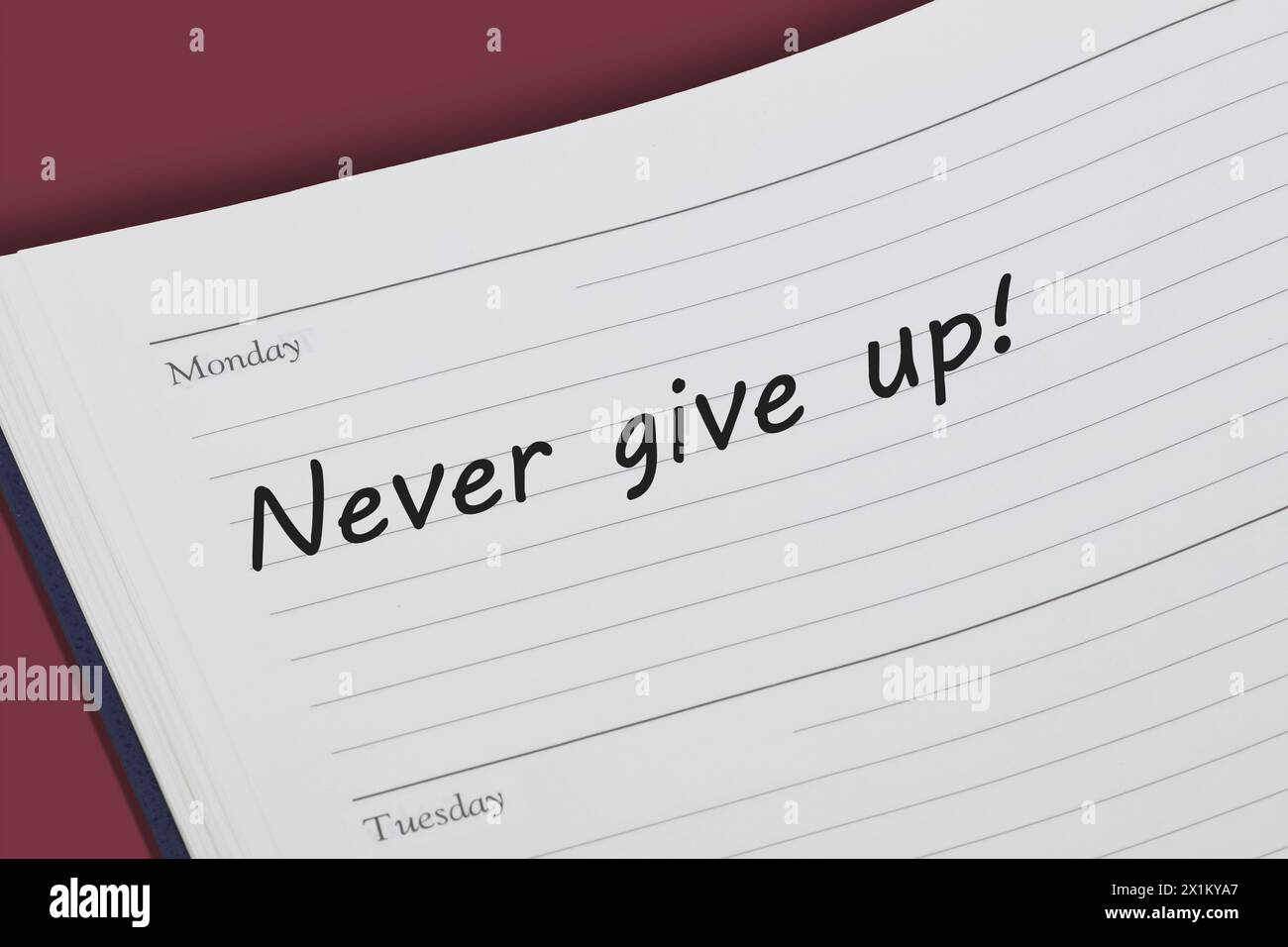 Never give up reminder message in an open diary Stock Photo - Alamy