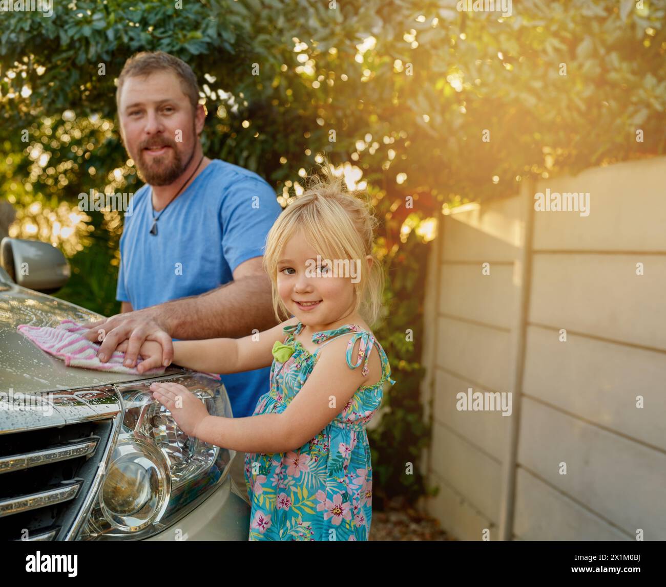 Outdoors, man and girl with cleaning car in backyard for maintenance ...