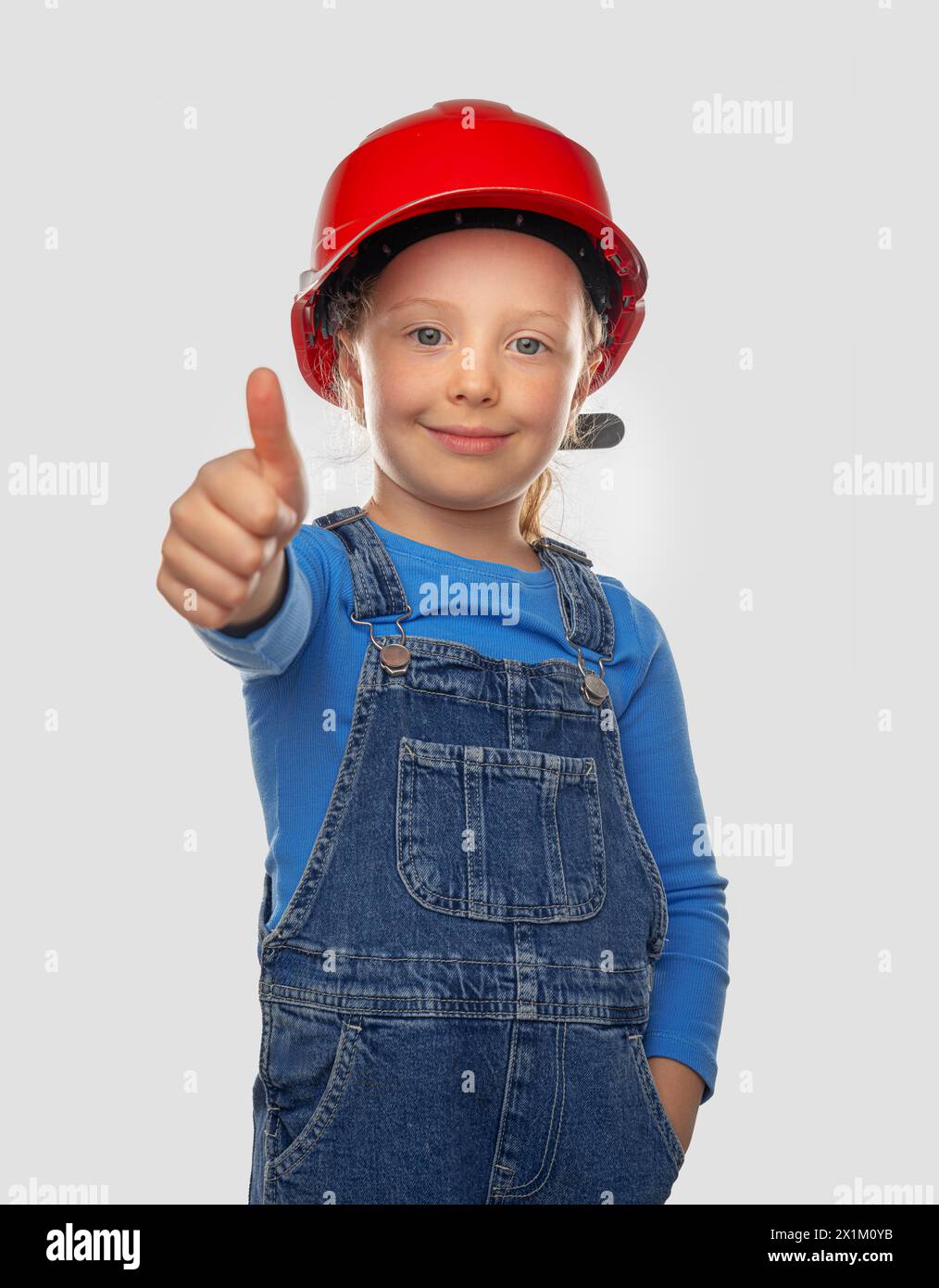 Little girl worker in a safety helmet with a tool Stock Photo - Alamy