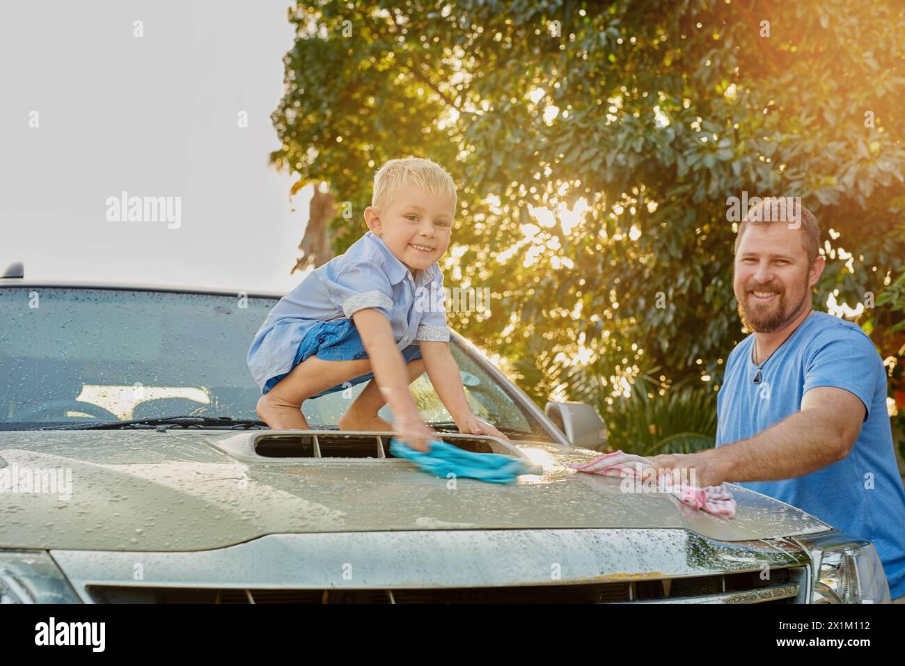 Outdoors, man and kid with cleaning car in nature for maintenance ...