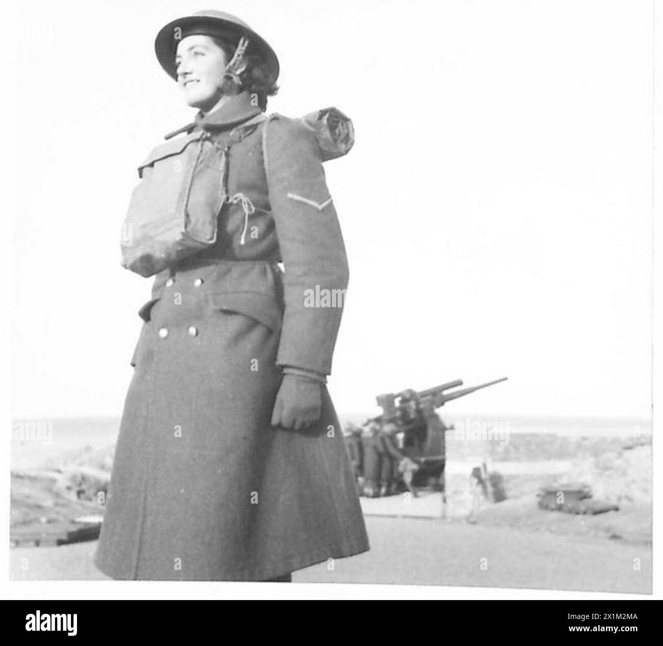 An ATS member is shown training to operate anti-aircraft batteries ...