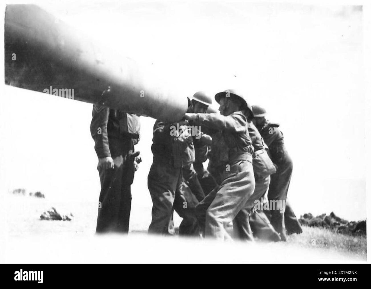 British Army personnel clean the breech of a coastal defence gun as ...