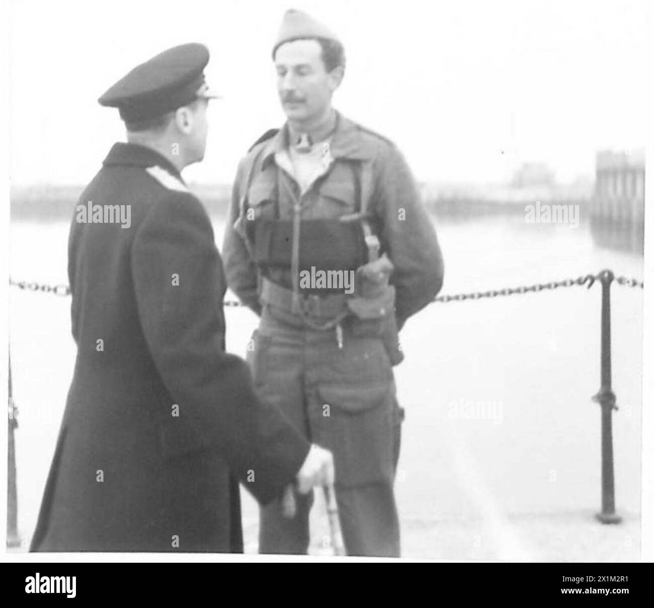 Major Lord Lovat, leader of a raid on the French coast, consults with ...