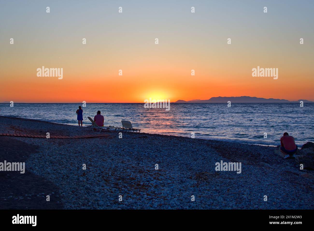 Sunset at the beach in Ialysos, Rhodes, Greece Stock Photo - Alamy