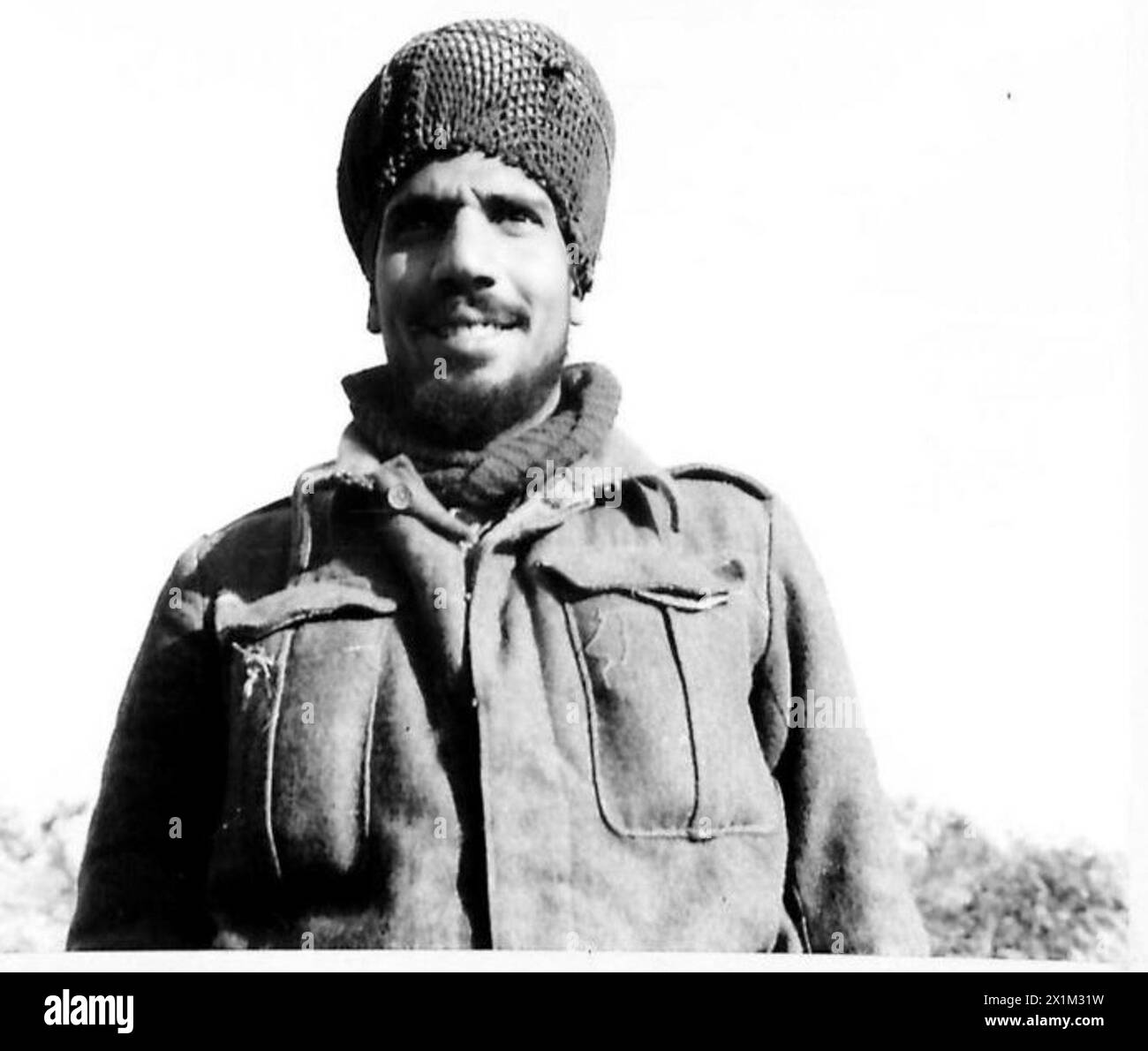 A Sikh soldier of the Eighth Army is pictured without a steel helmet ...