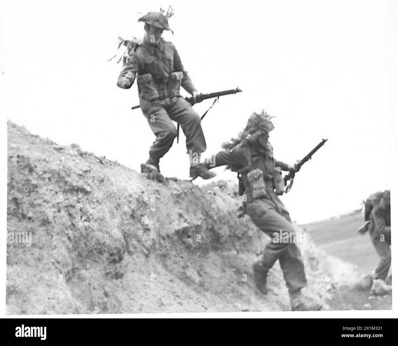 Soldiers of the Coldstream regiment take cover during attack exercises ...