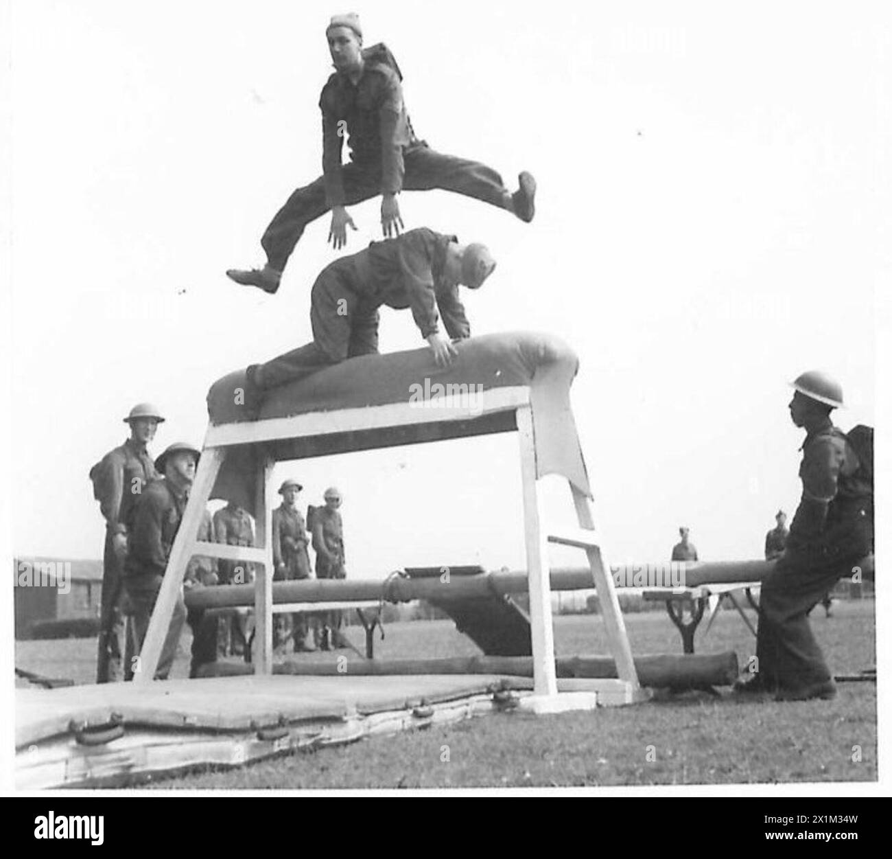 An instructor demonstrates leapfrog exercises in battle order during ...