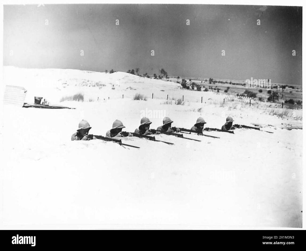 Scottish troops conduct firing practice in a defence trench in the ...