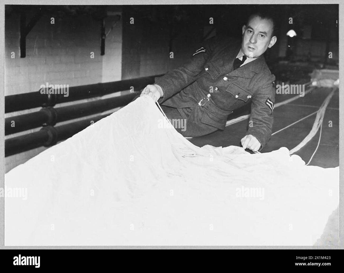 HIS WORK SAVES LIVES - The corporal packs another parachute for the ...