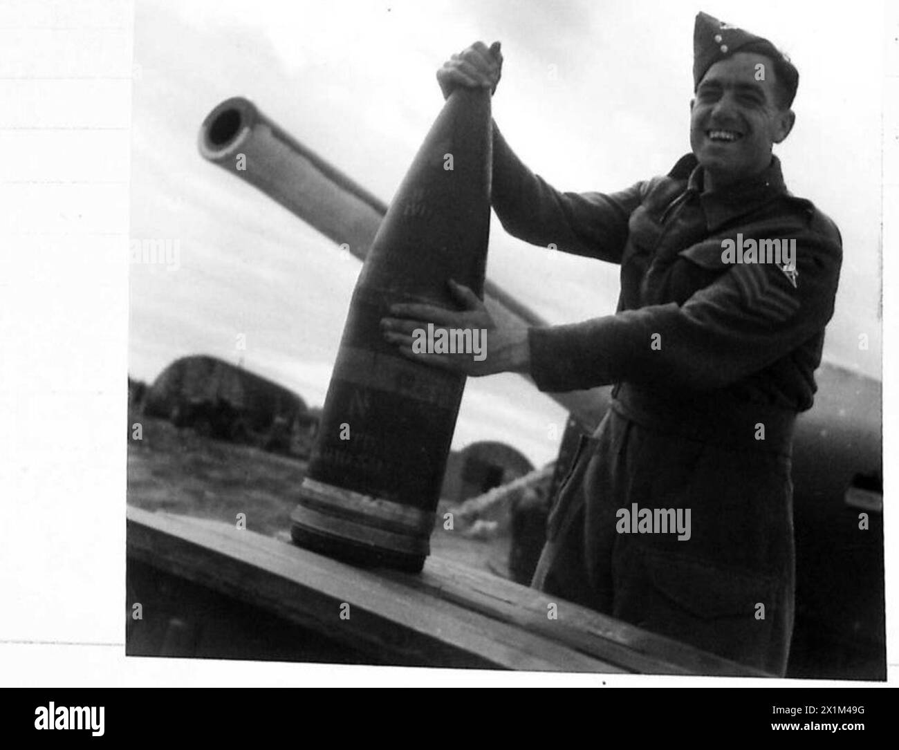 STRENGTHENING BRITAIN'S COAST DEFENCES - A sergeant gunner handles one ...