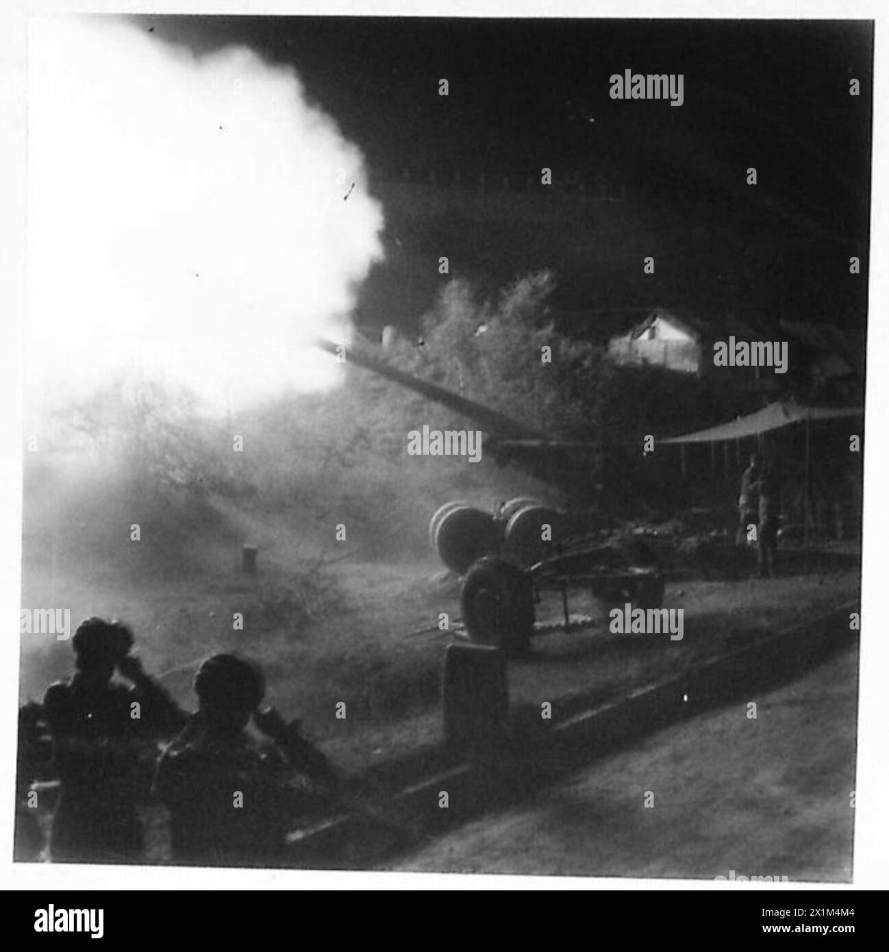 FIFTH ARMY : VARIOUS - A 155 mm gun in action at night. The flash from ...