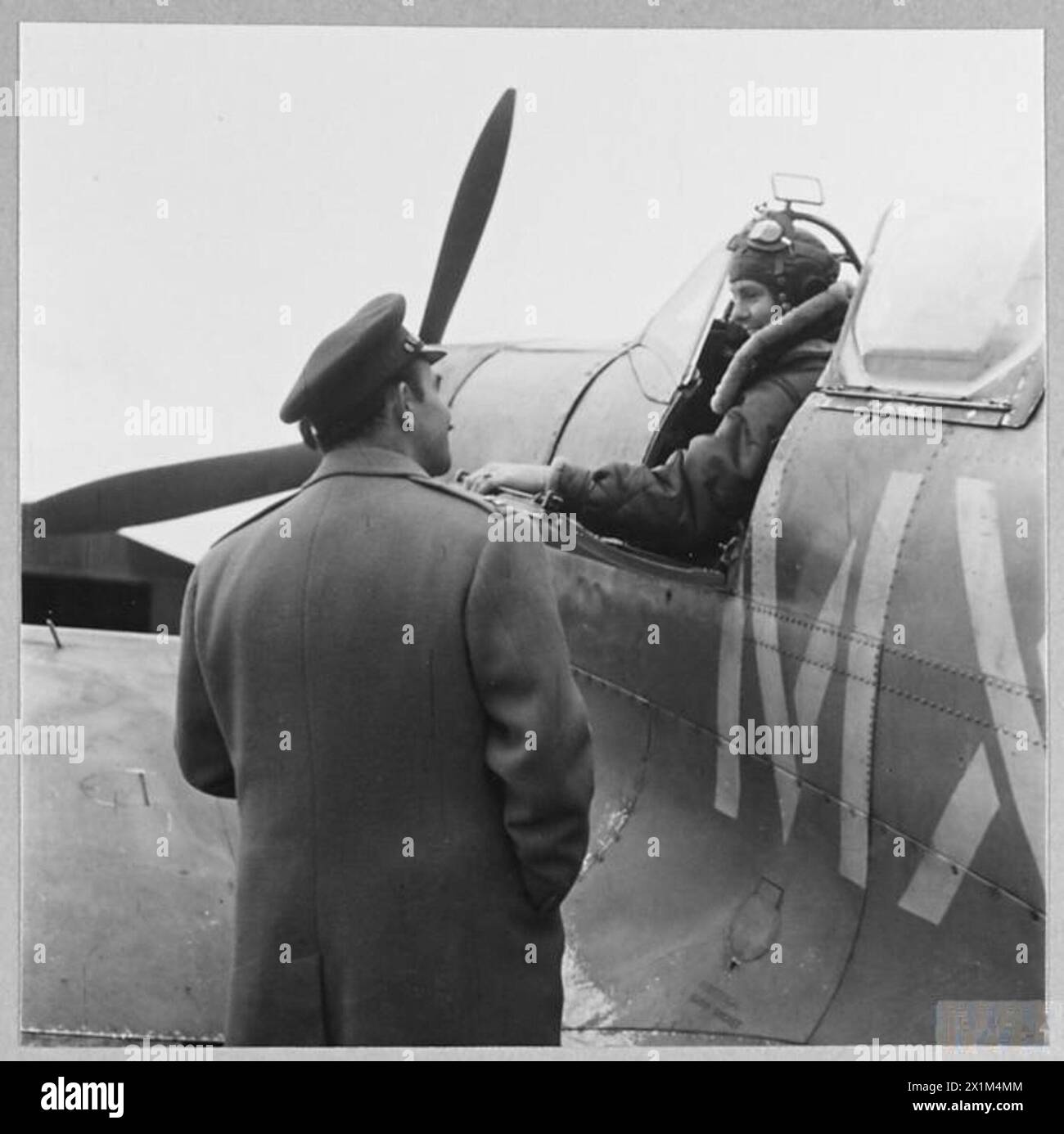 U.S. Spitfire pilots use British flying equipment at a RAF station ...