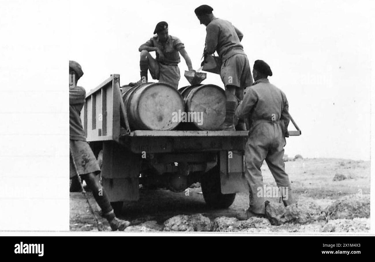 A British Army desert water convoy collects fresh water, transferring ...