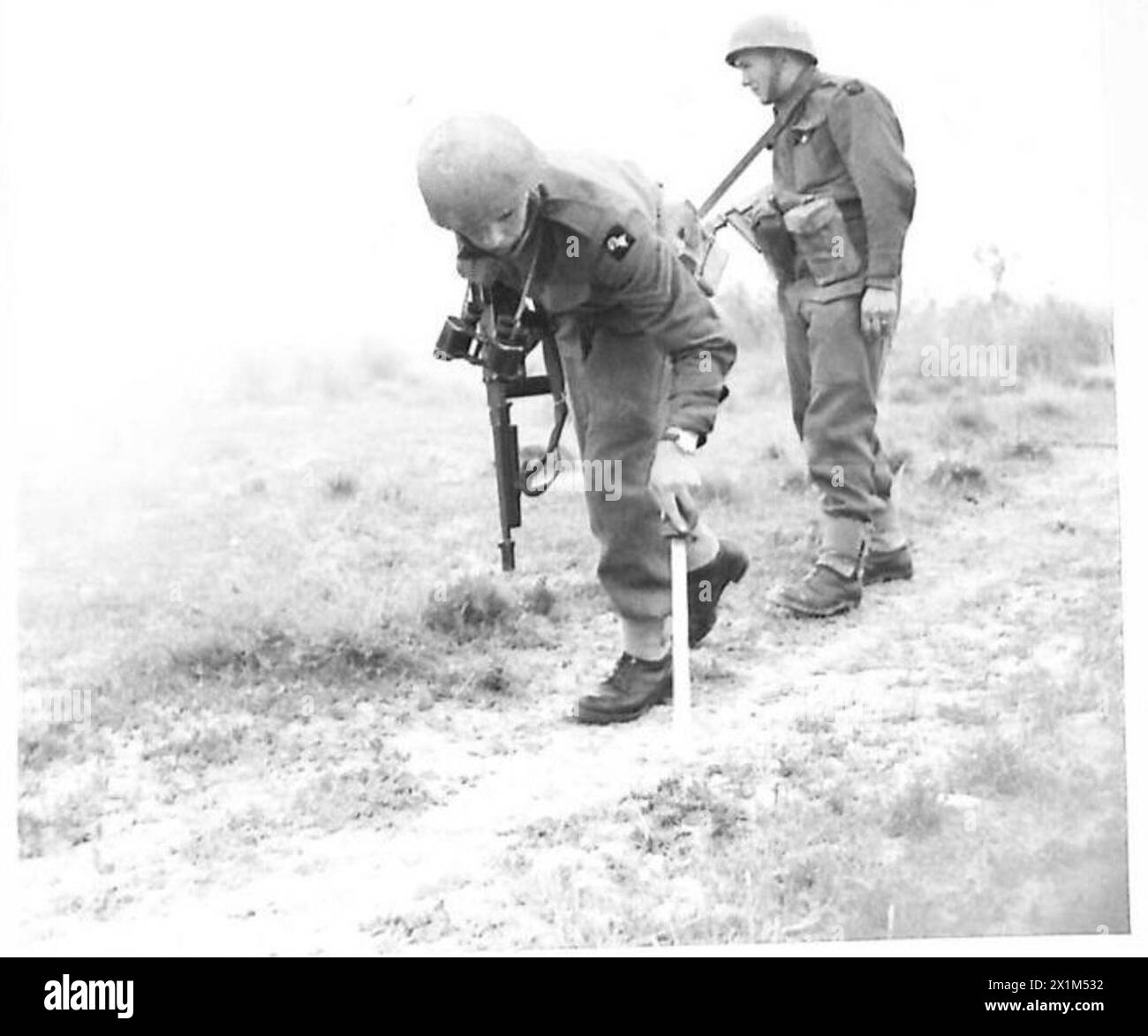 Reconnaissance infantry advance under a smoke screen probing for mines ...