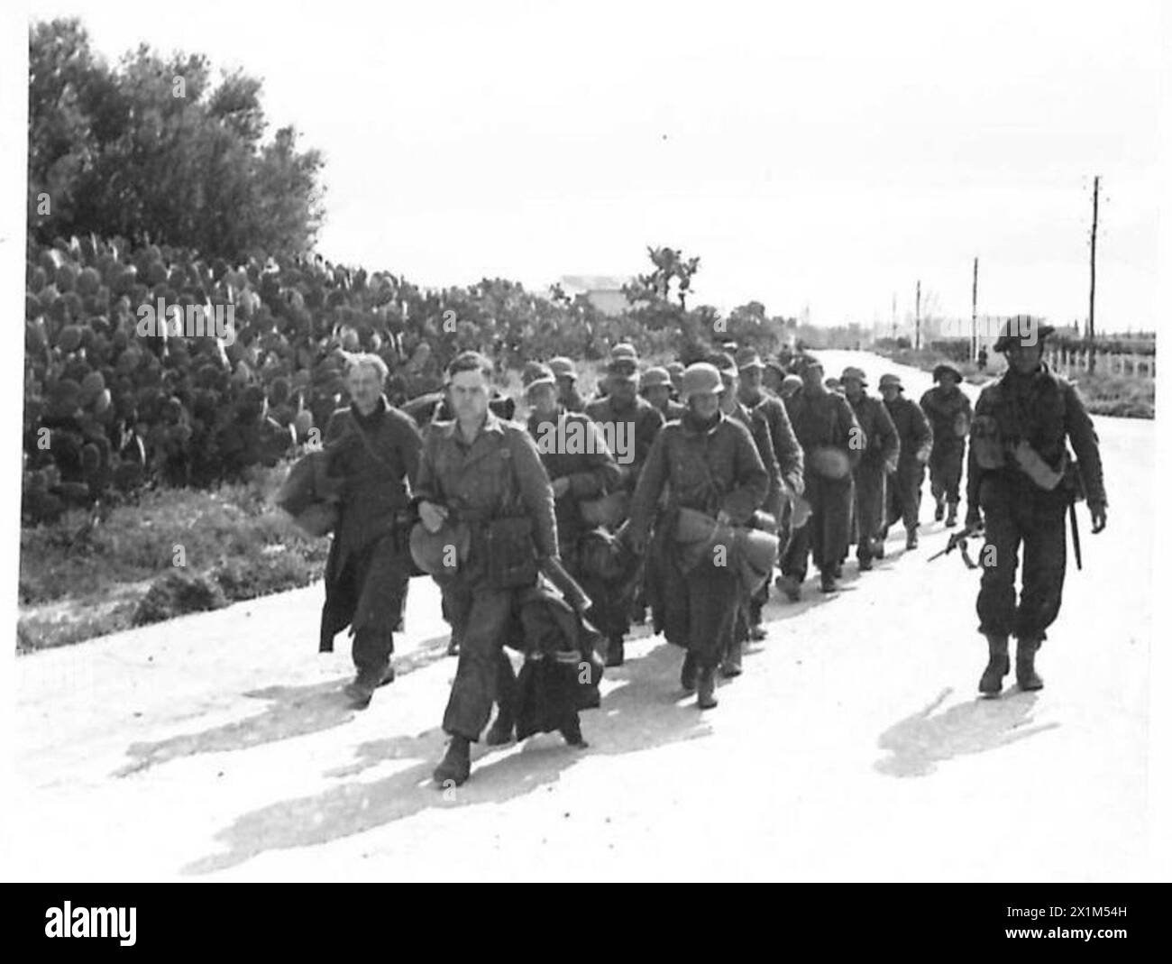 German prisoners are escorted by British Army personnel following a ...