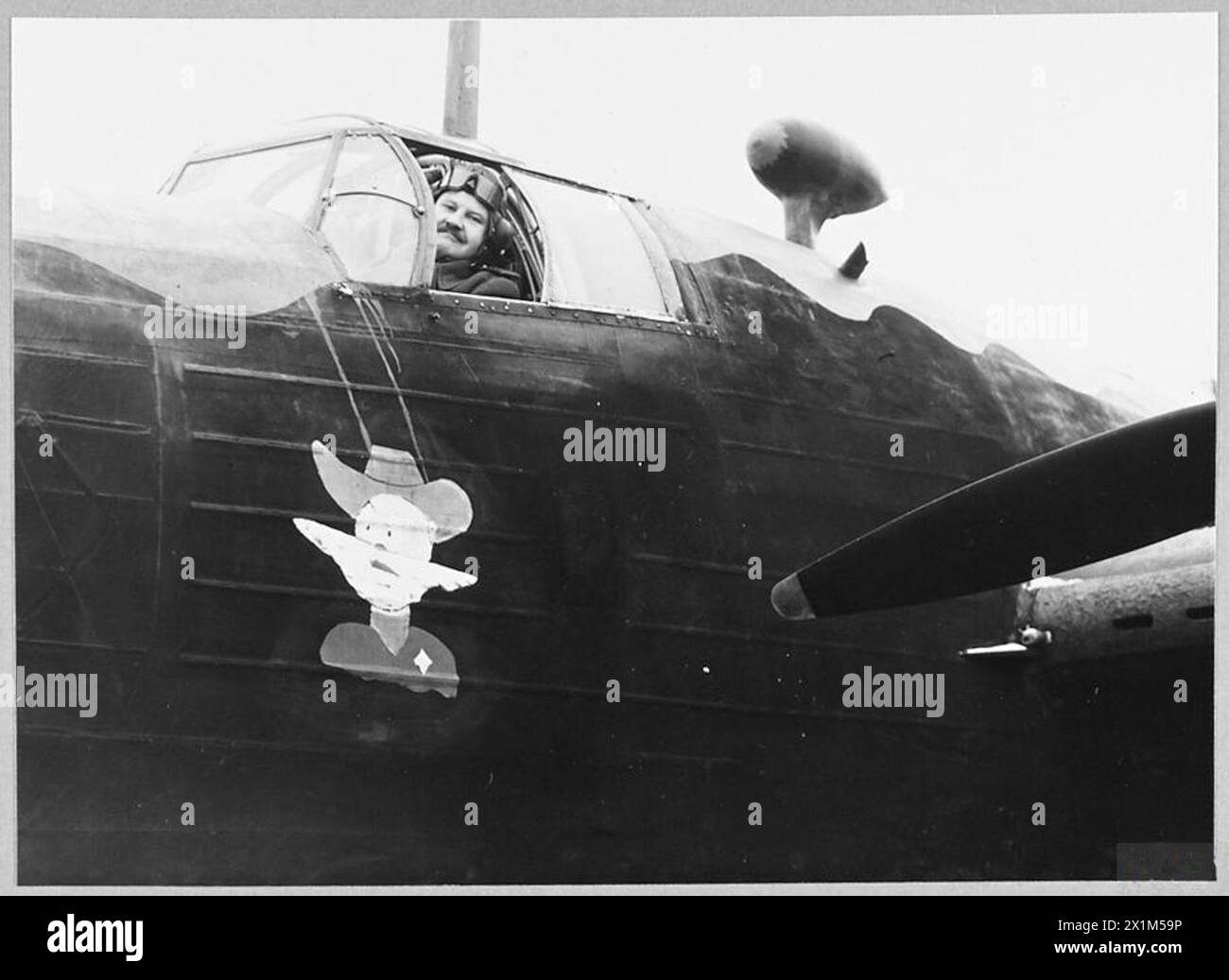 AT AN R.A.F. BOMBER STATION - Group Captain Evan Evans in the ...
