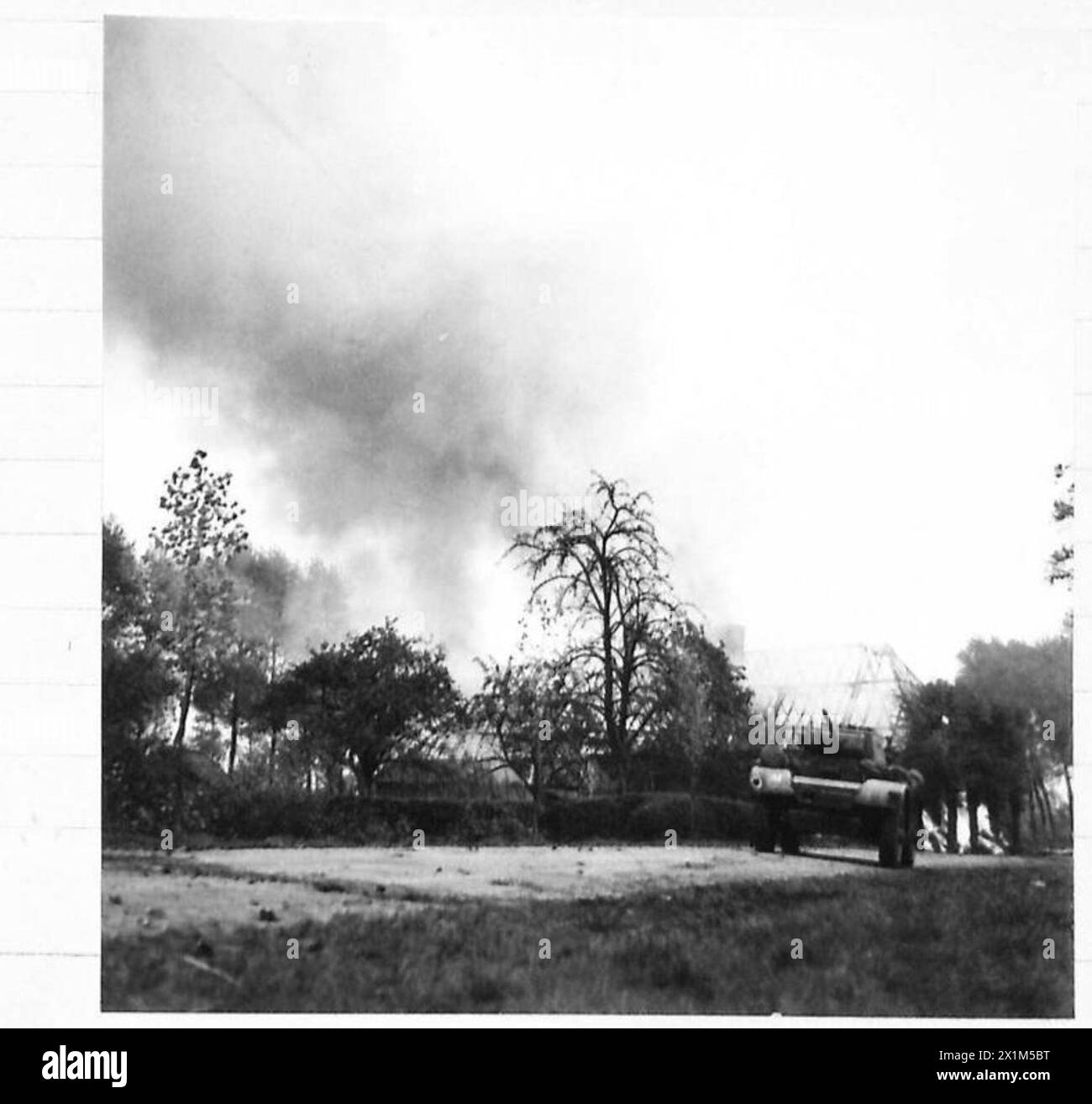 SAME STORY. - Reece car with burning house in background, British Army ...