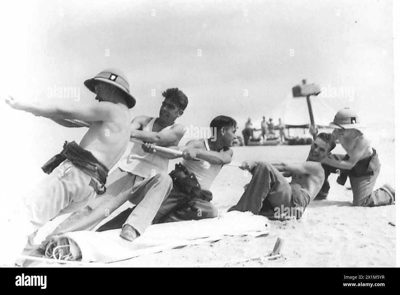 INFANTRY TRAINING IN THE DESERT - A good pull is necessary to tighten ...