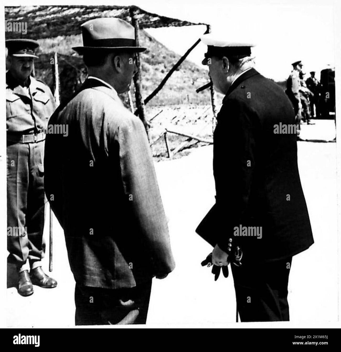 Prime Minister Winston Churchill talks with Colonel Stimson while ...