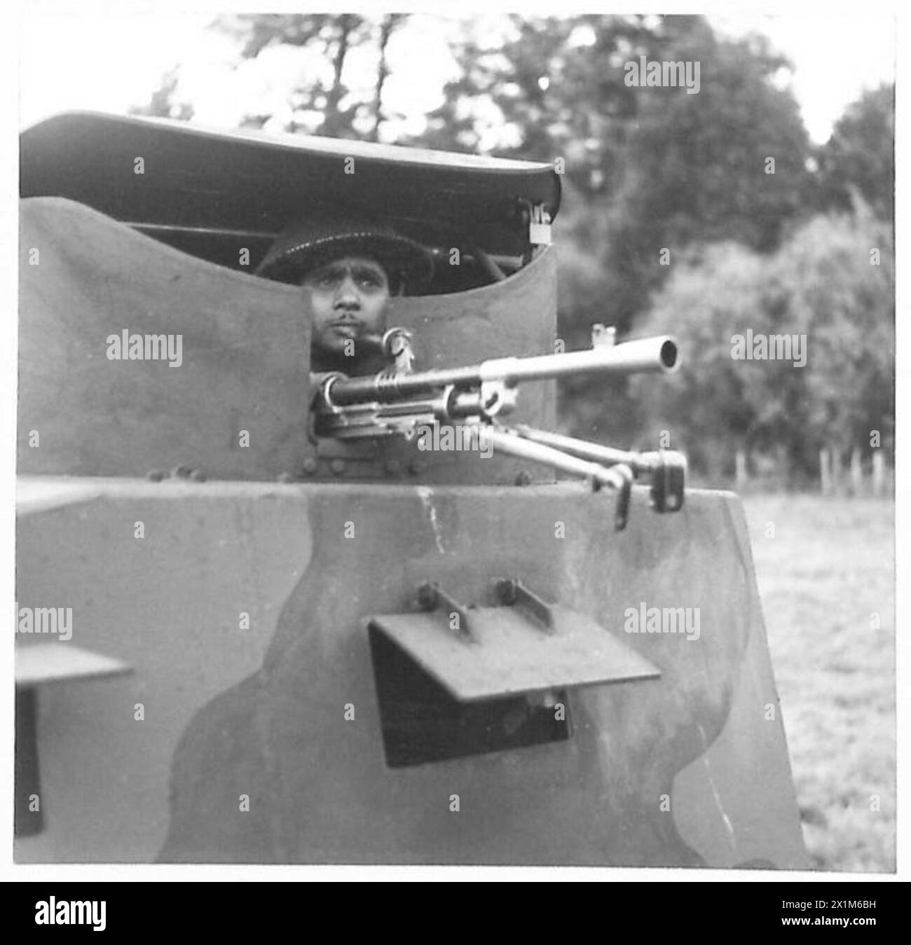 A Bren gunner observes from the turret of a reconnaissance vehicle in a ...