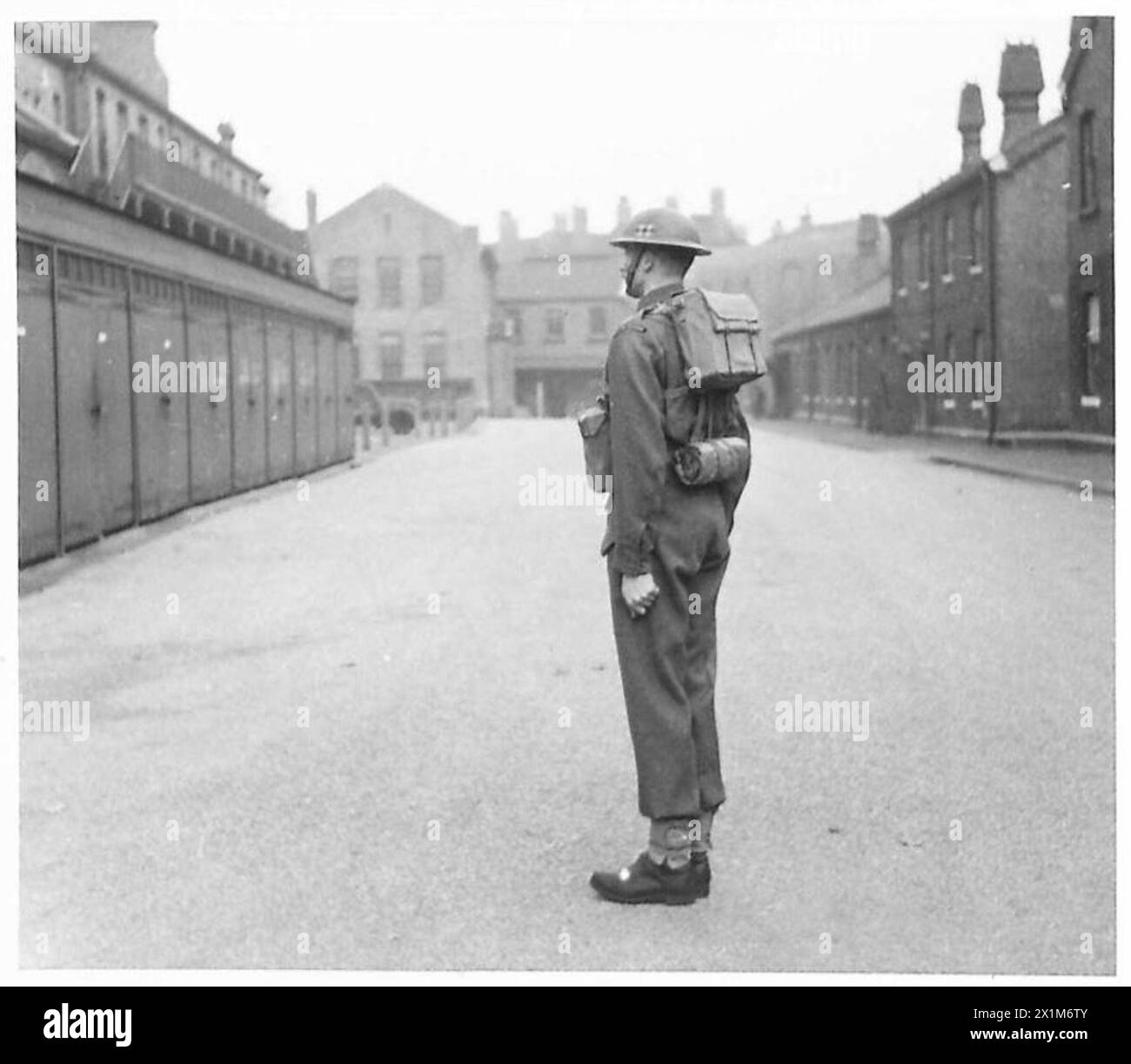 SOLDIER WEARS HIS EQUIPMENT - Side view of soldier wearing Battle dress ...