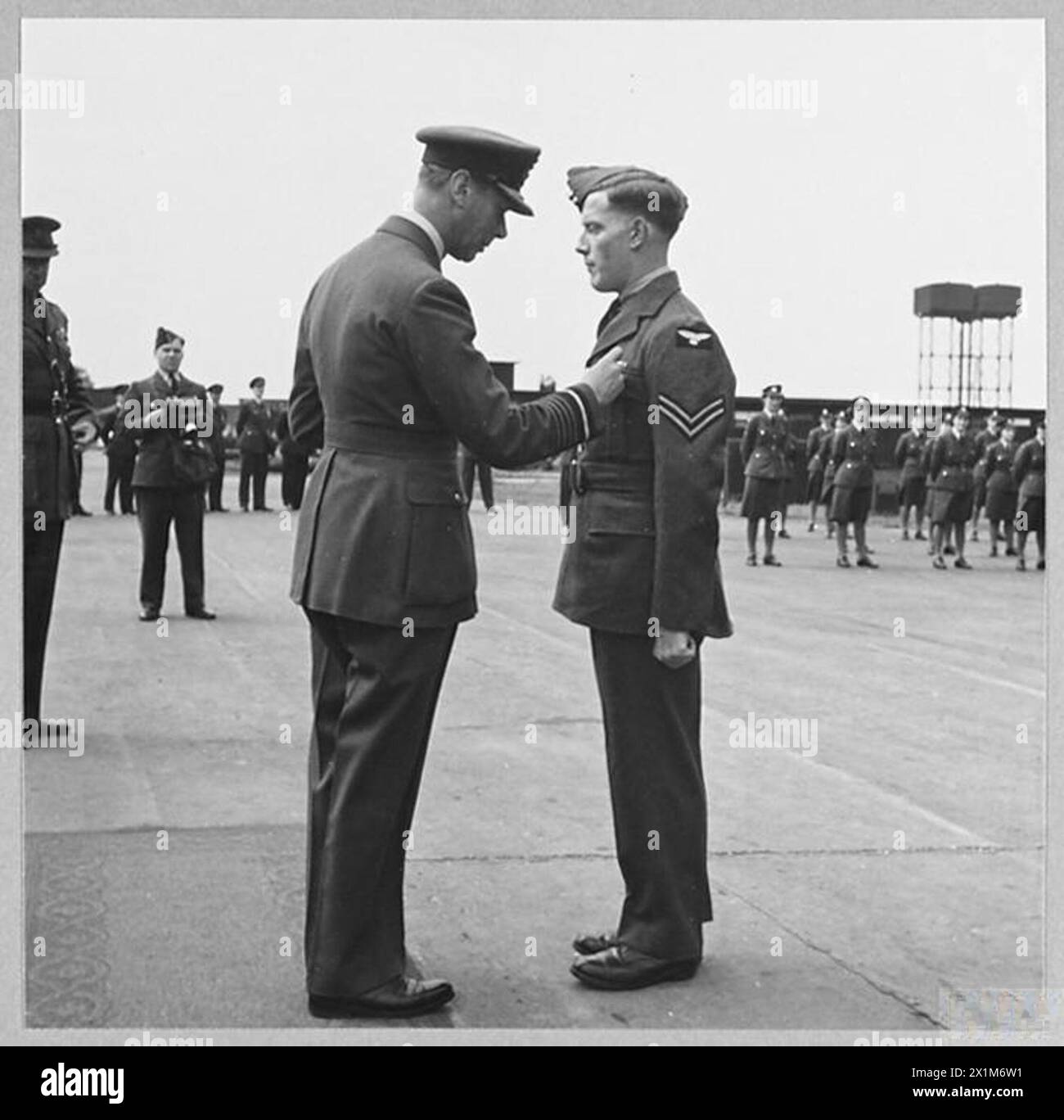 In 1944, Corporal V.L. Maynard of Iver, Buckinghamshire, receives the ...