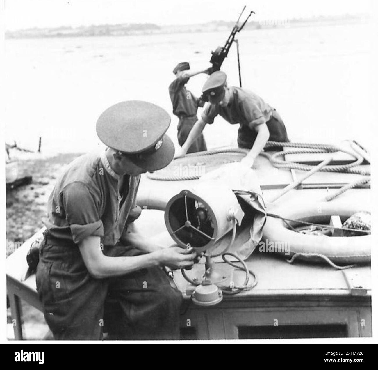 THE ARMY'S NAVY - Checking over one of the signalling lamps aboard the ...