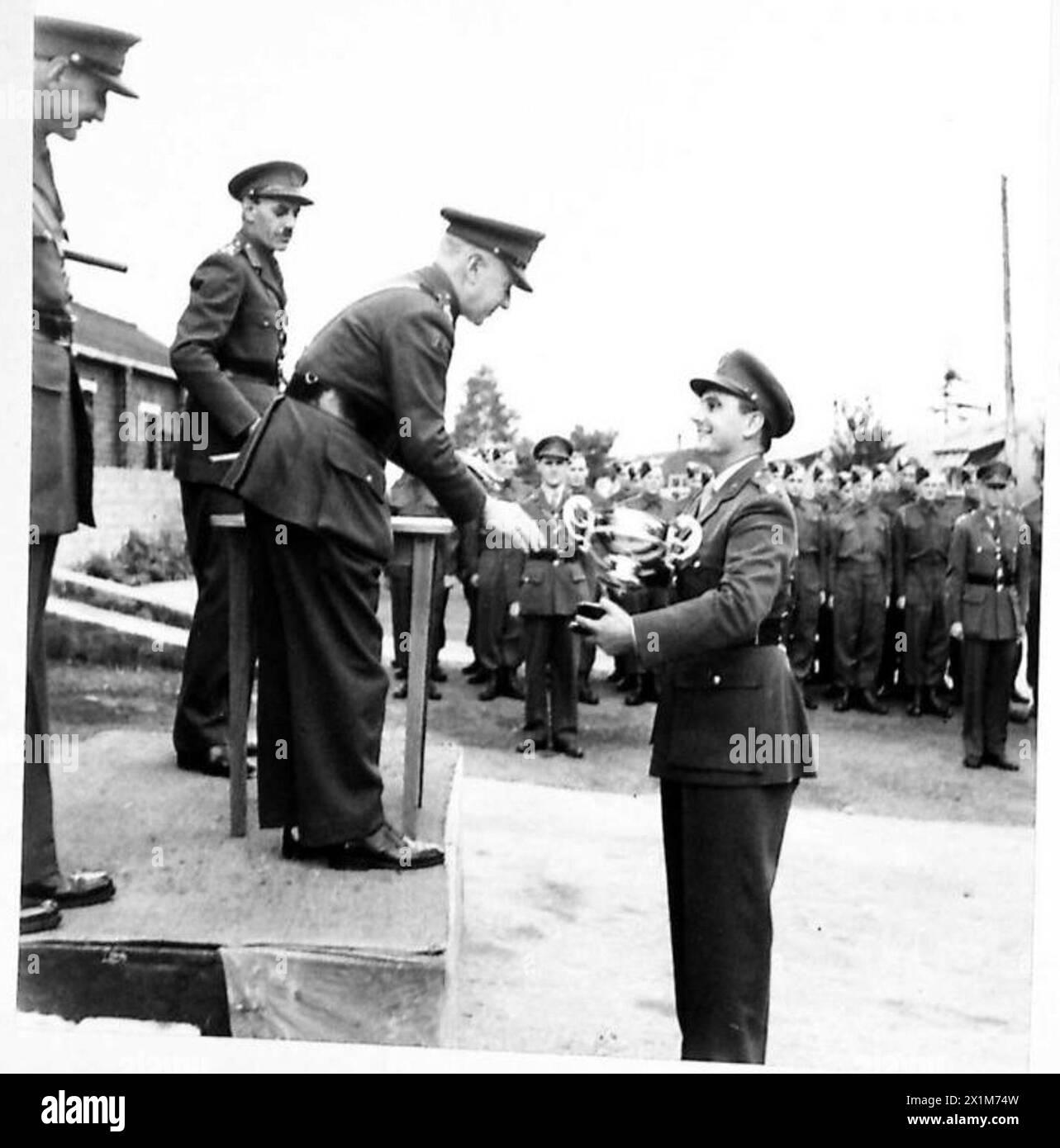 General Sir F.A. Pile presents a cup to the Battery Commander of a ...