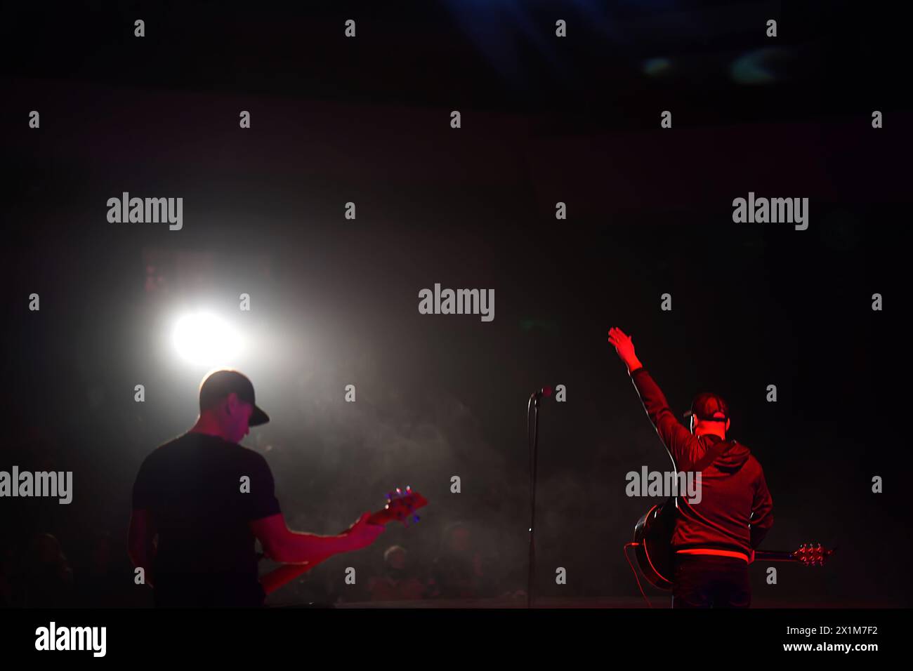 Rock band vocalist silhouette with the guitar singing to microphone ...