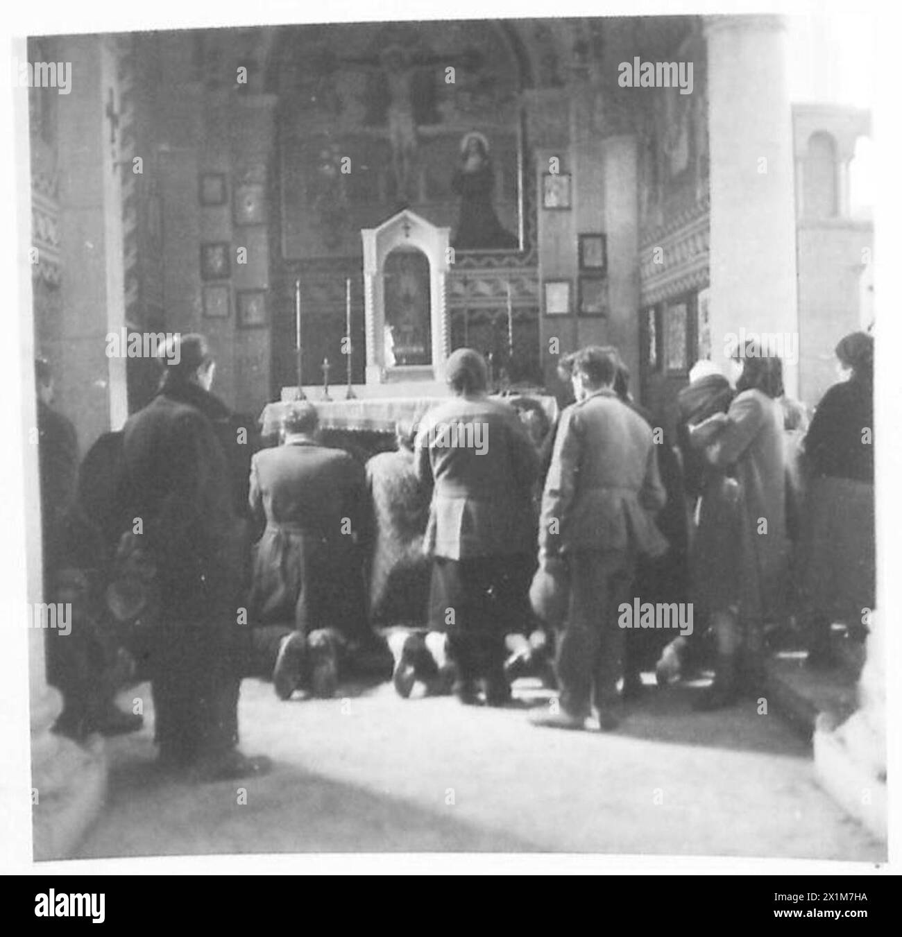 Refugees at the Anzio bridgehead gather to pray in a church while under ...