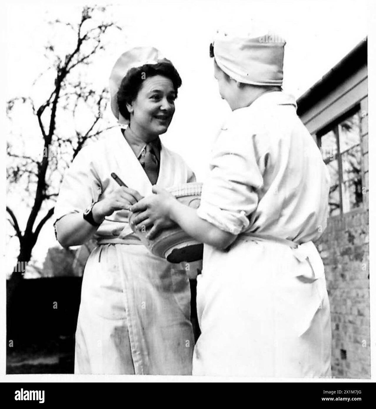 ATS SCHOOL OF COOKERY - The Sergeant Major assists an auxiliary and ...