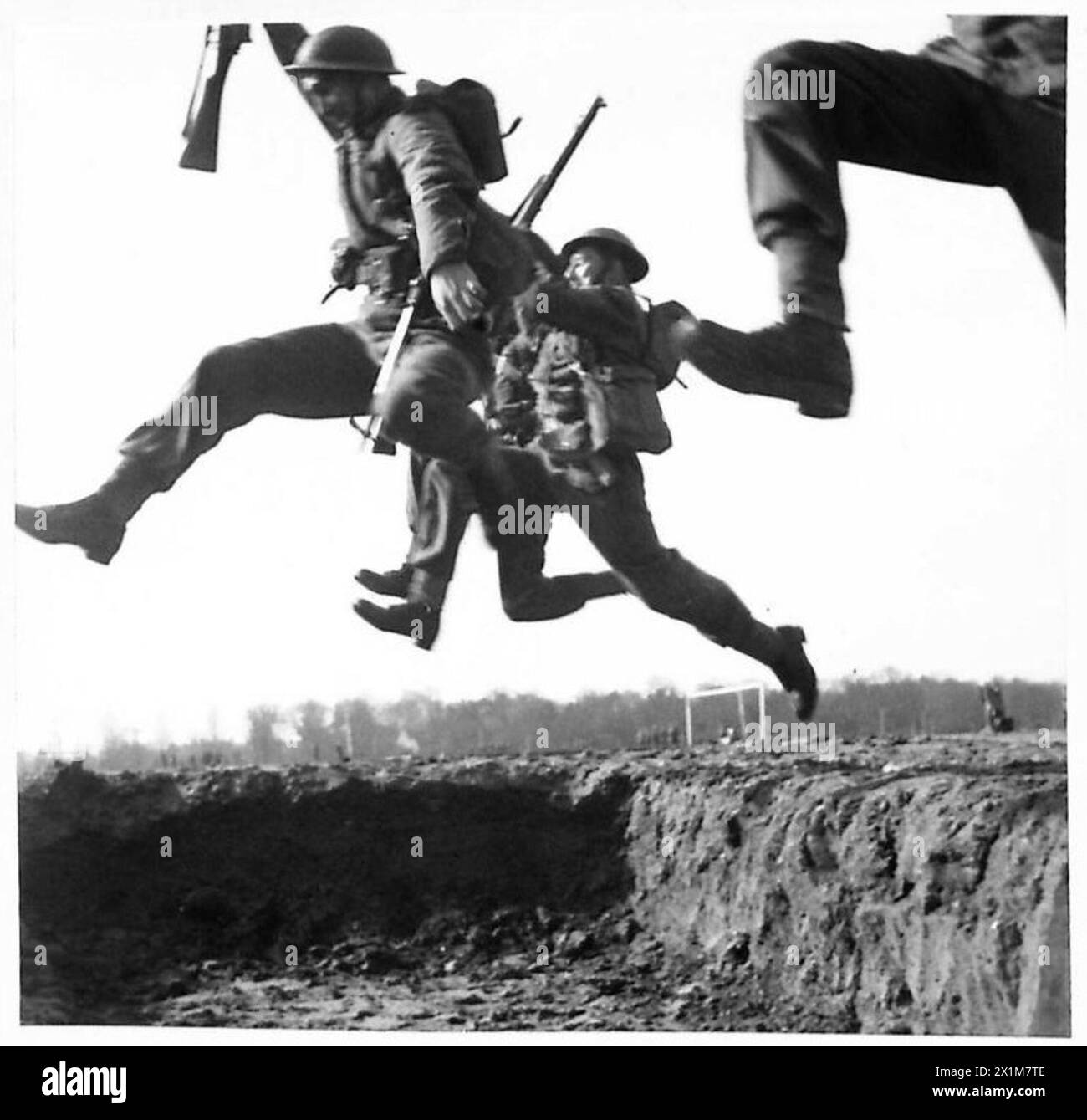 Soldiers are shown leaping over a nine-foot ditch as part of physical ...