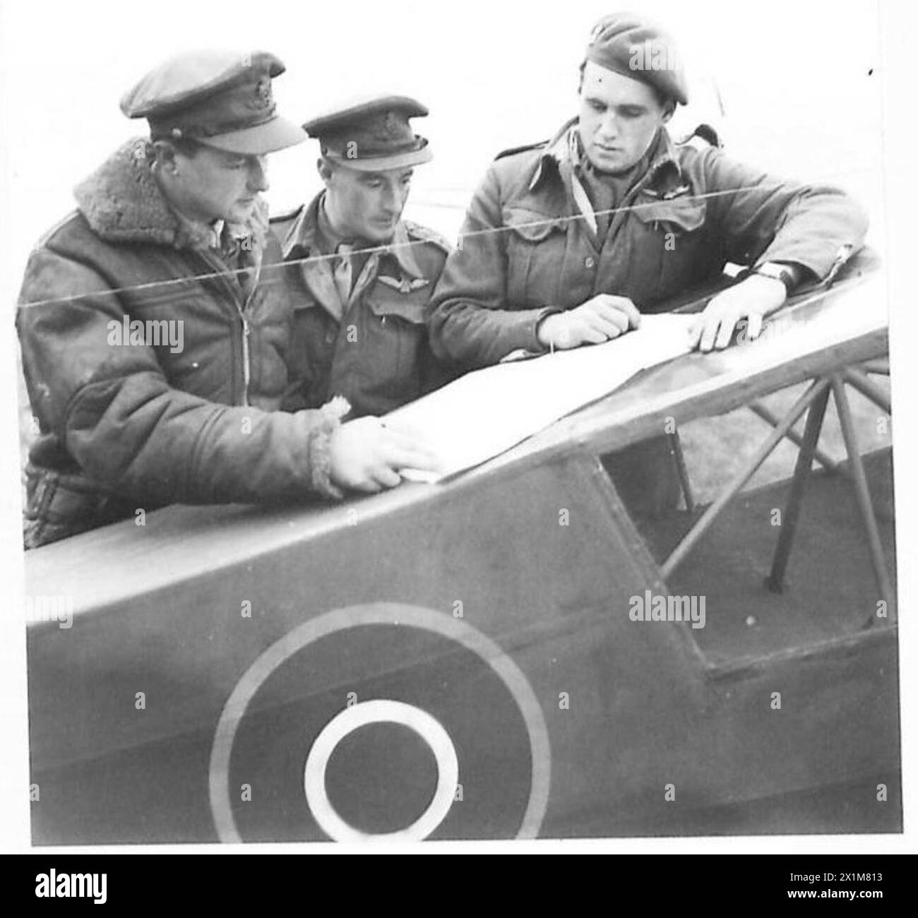 655 Squadron Artillery Observation Post pilots study maps before flying ...