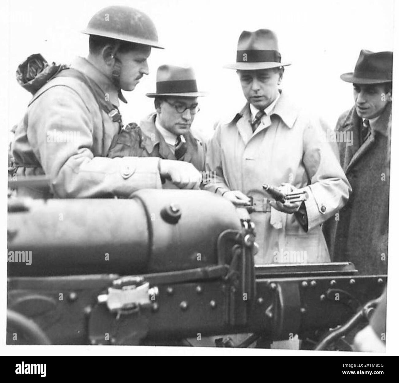A British Army officer explains the technical details of a field gun to ...