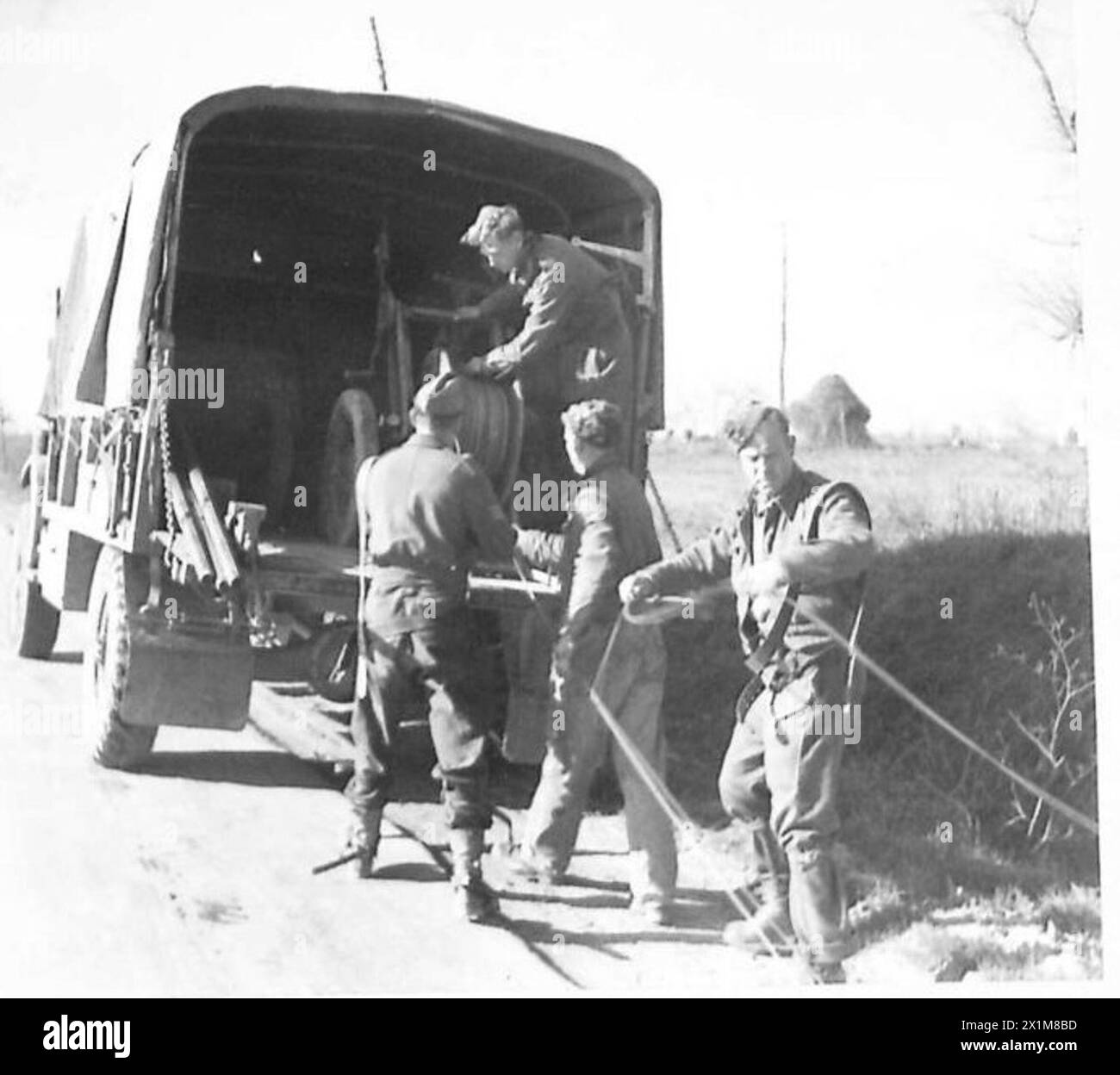 British Army linemen of the Fifth Army follow a lorry while unwinding ...