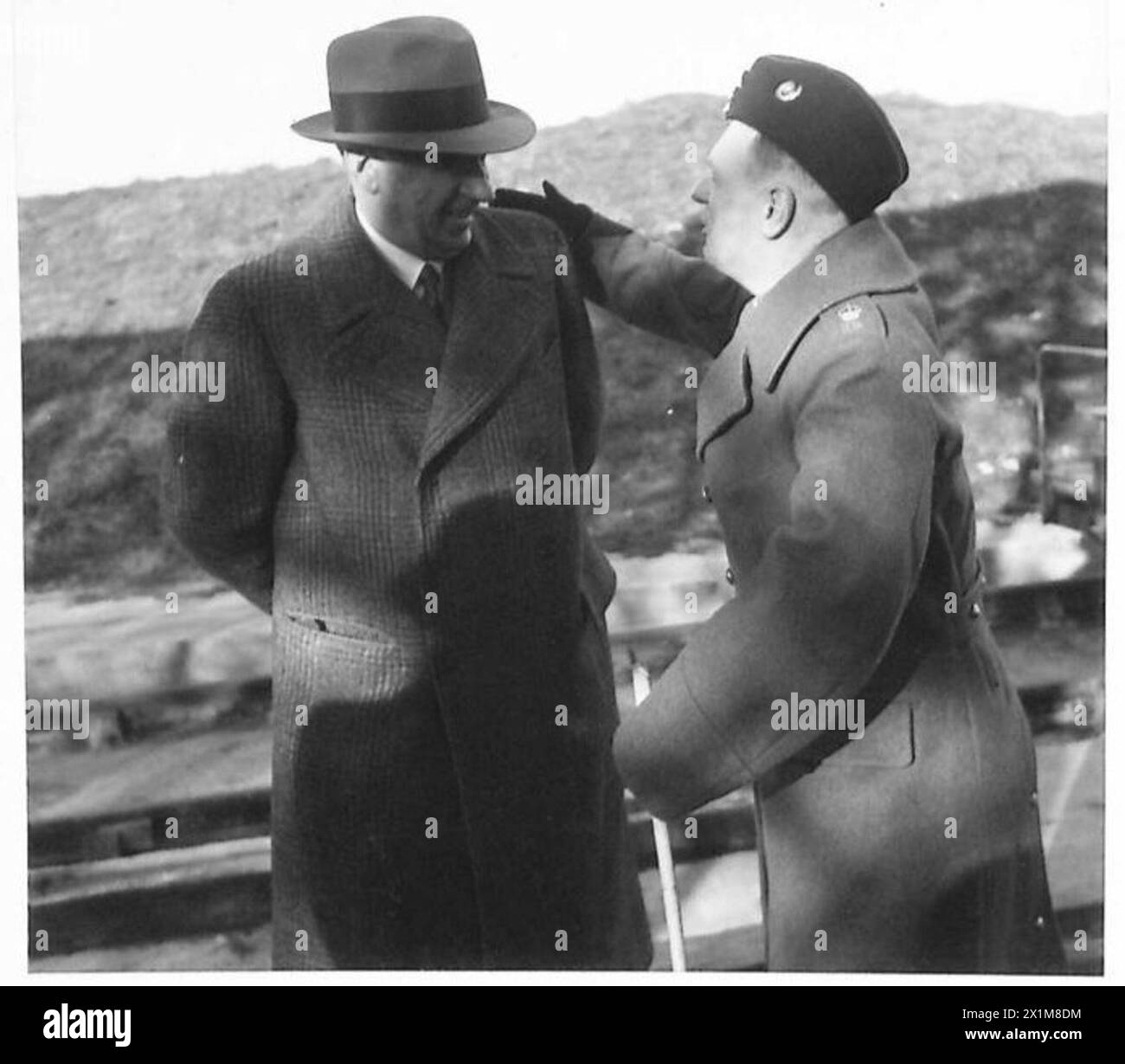 Sir Keith Murdoch speaks with a military officer on a gun emplacement ...