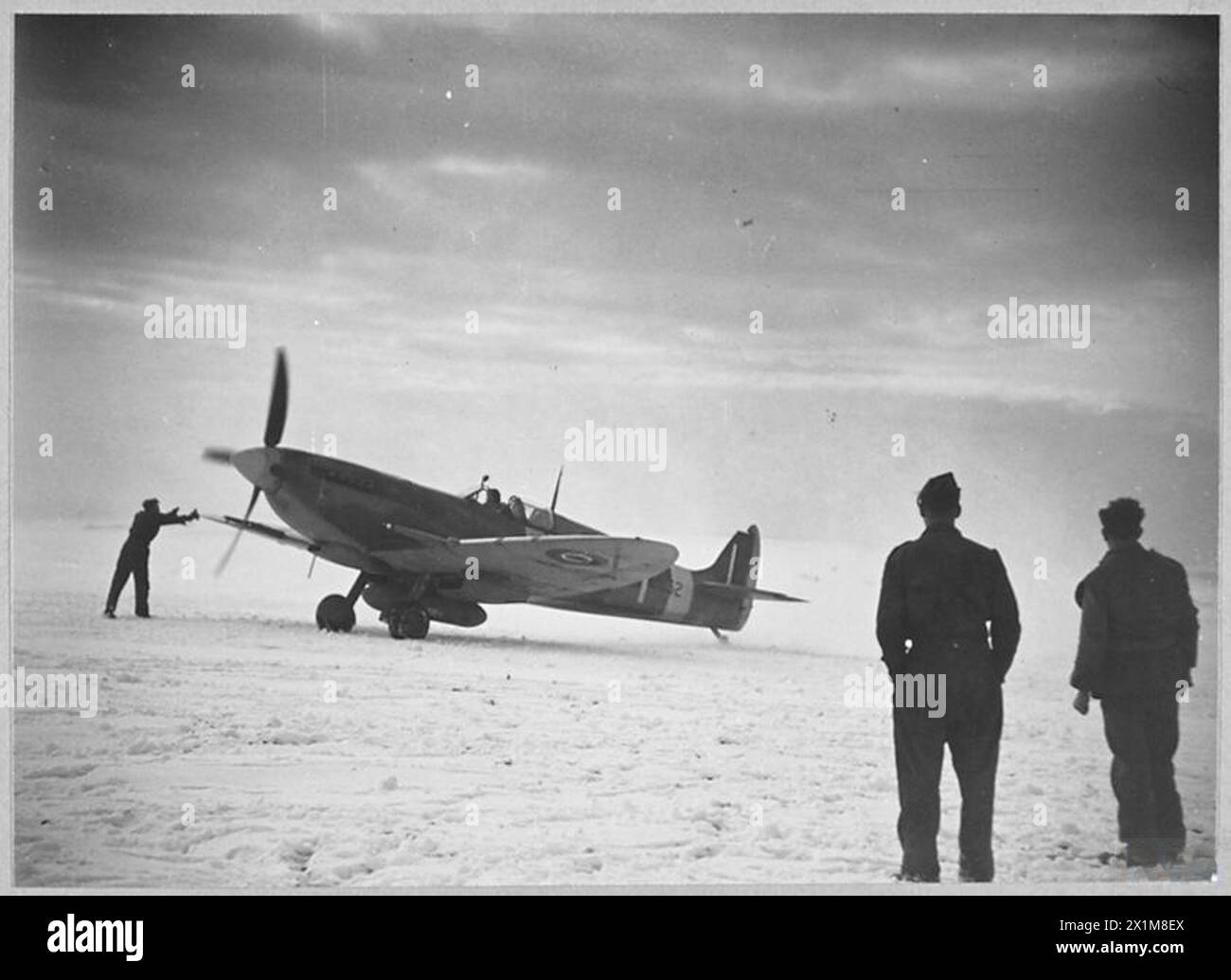 SNOW AT A SPITFIRE STATION IN BRITAIN - Picture (issued 1944) shows - A ...