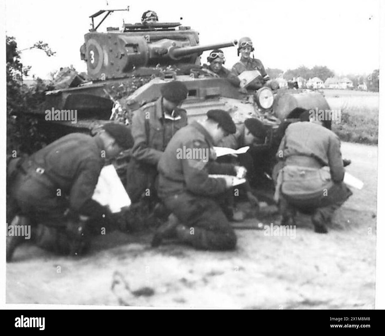 Tank crews of the British Army discuss their campaign plan during a ...
