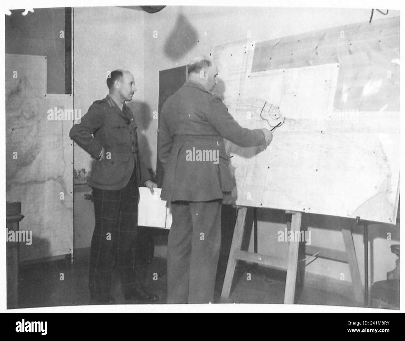 Lieutenant General Sir H. Maitland Wilson of the British Army studies a ...