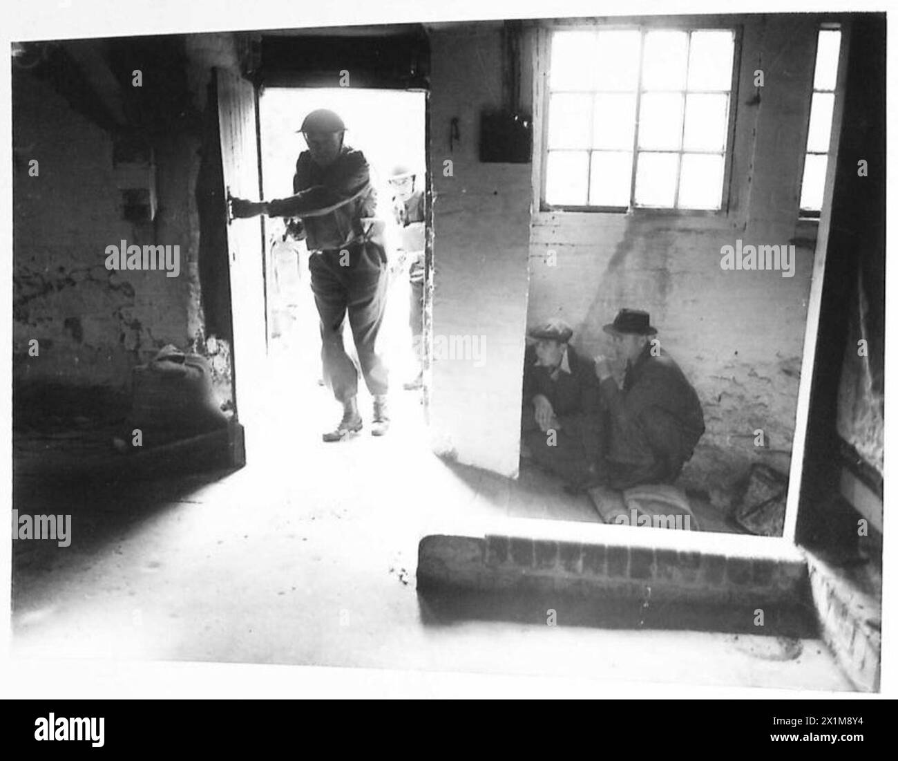 Home Guard units, led by officers, enter a mill to search for spies ...
