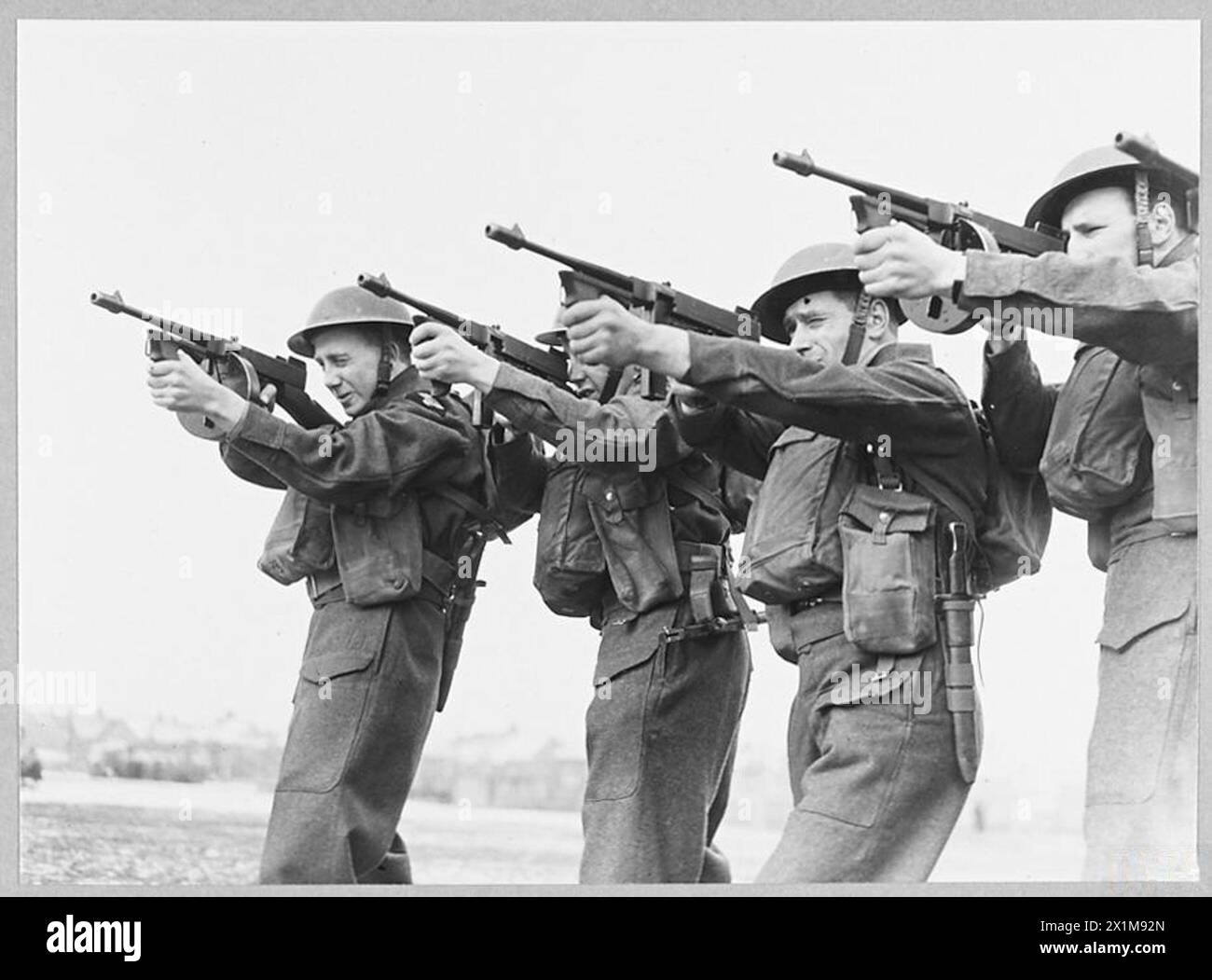 RAF personnel in battledress receive training in handling a Tommy gun ...