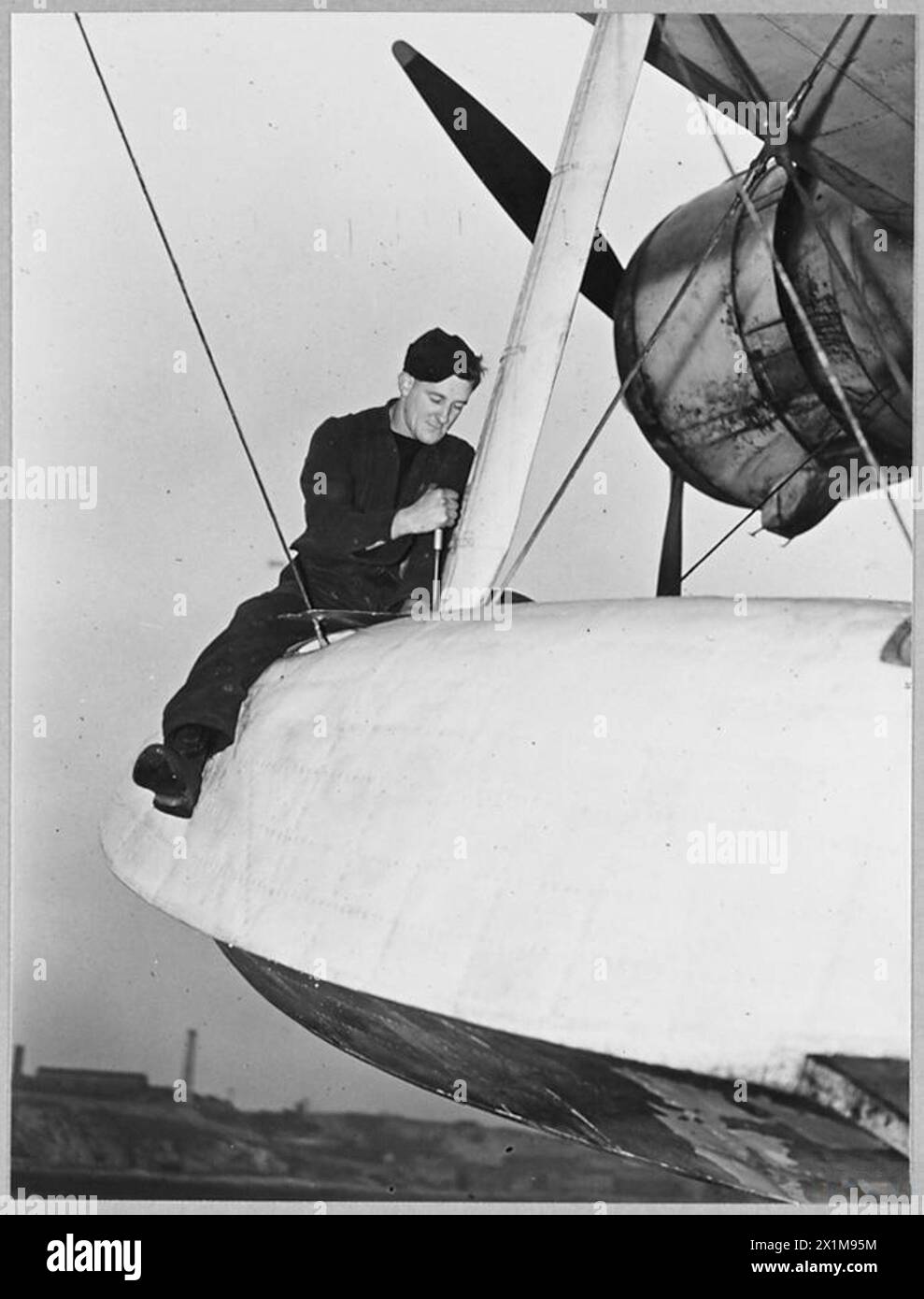 Leading Aircraftman Angus McVinish of Brisbane works on a float of a ...