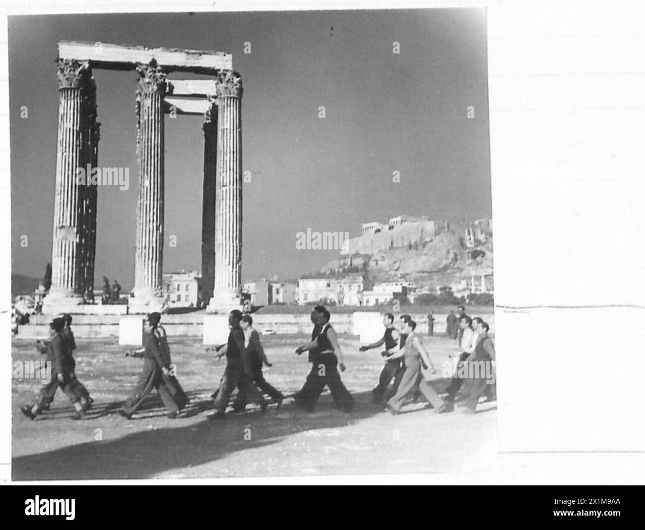New recruits of the Greek National Guard march past the ruins of the ...