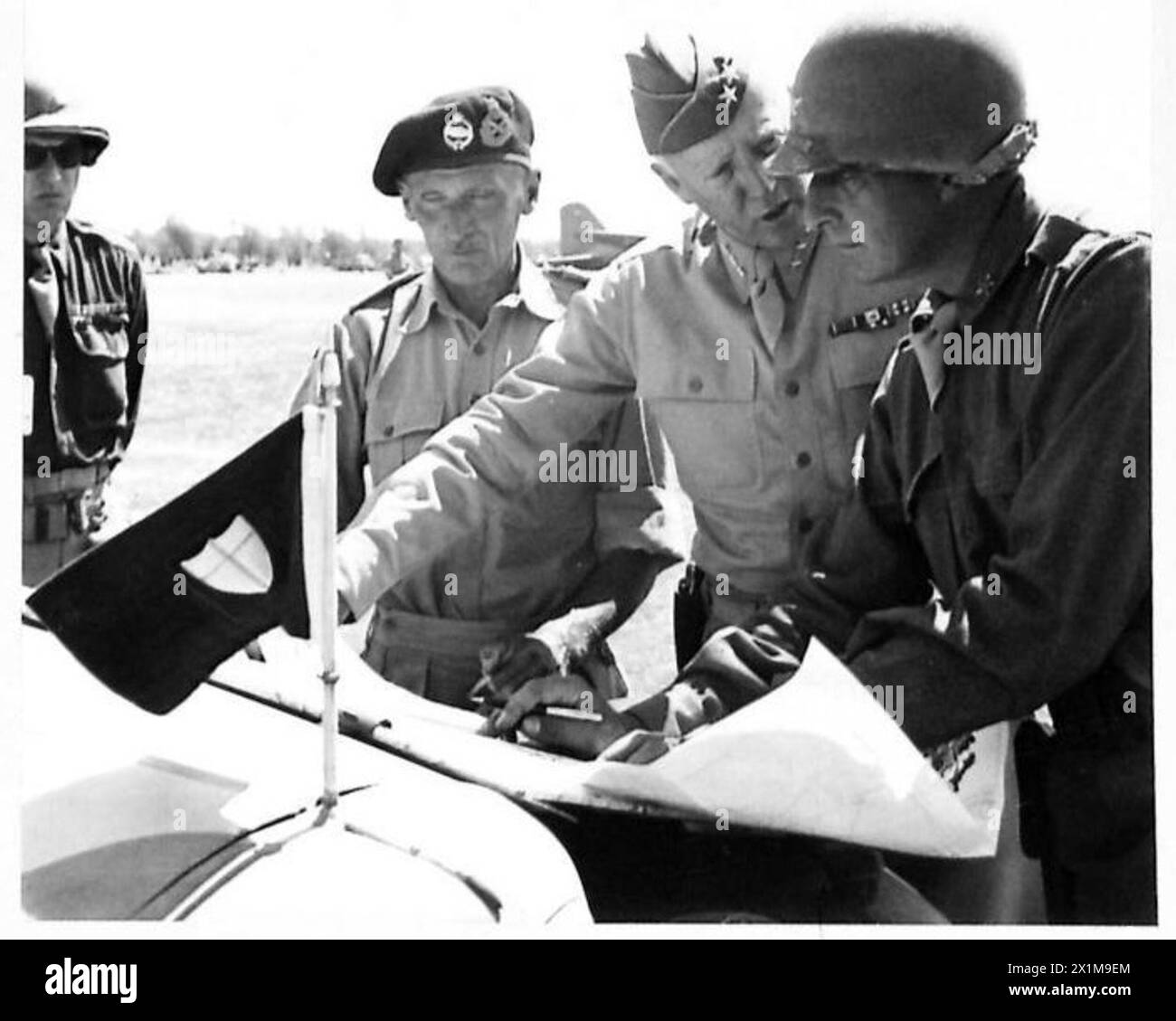 General Patton explains tactical points to his staff while General ...