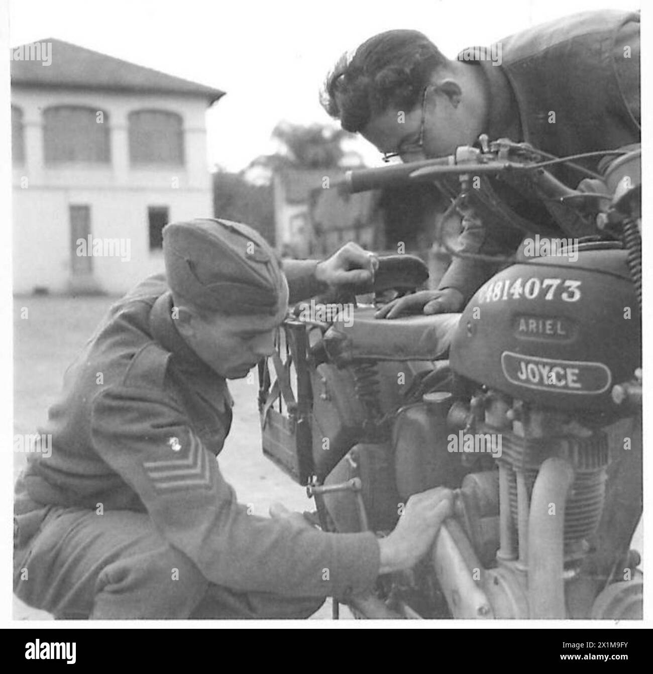 Sgt. H. Downing instructs Cpl. Noon on motorcycle spare parts at 9 ...