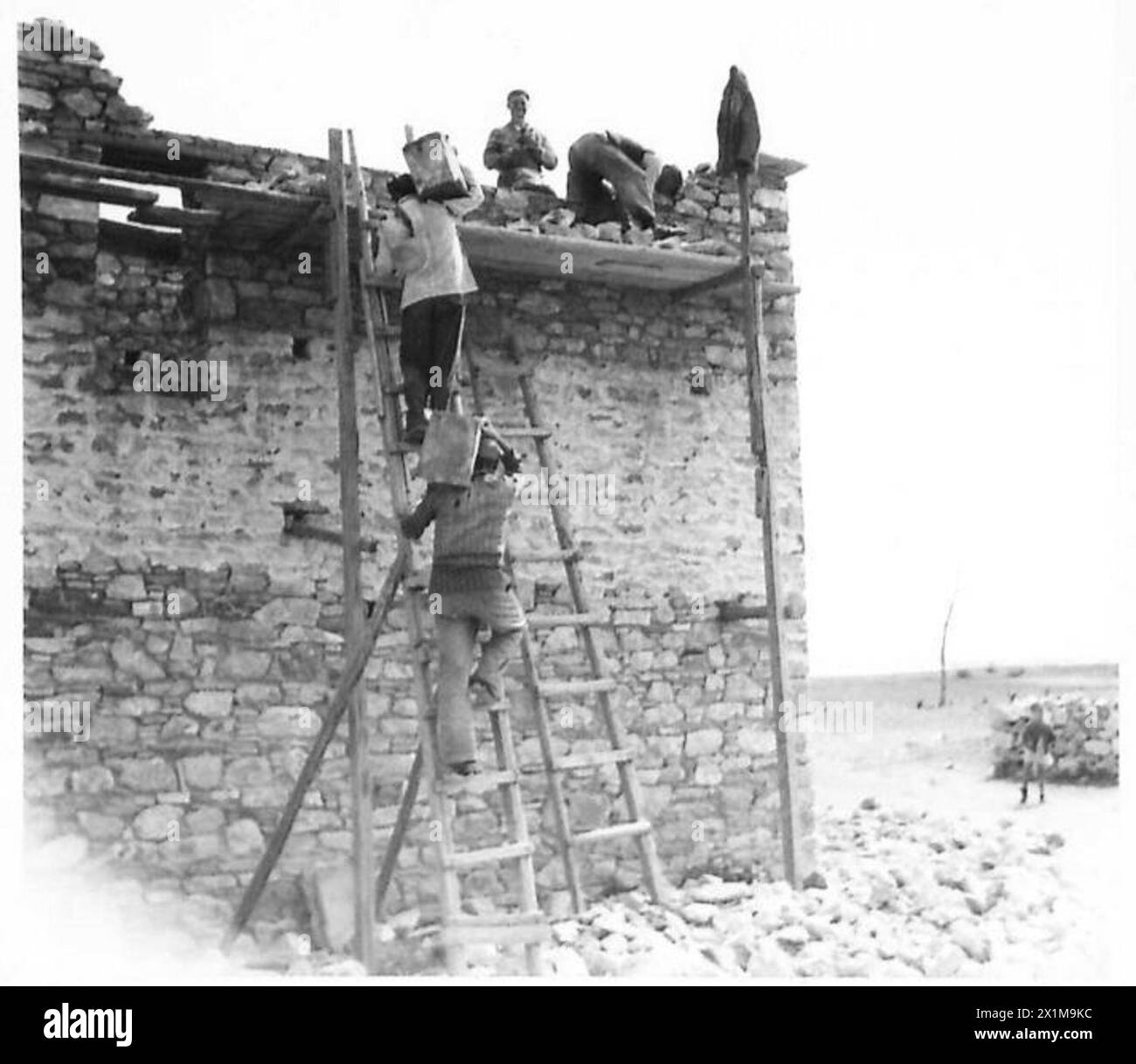 Labourers work on reconstructing a house in Greece destroyed by German ...