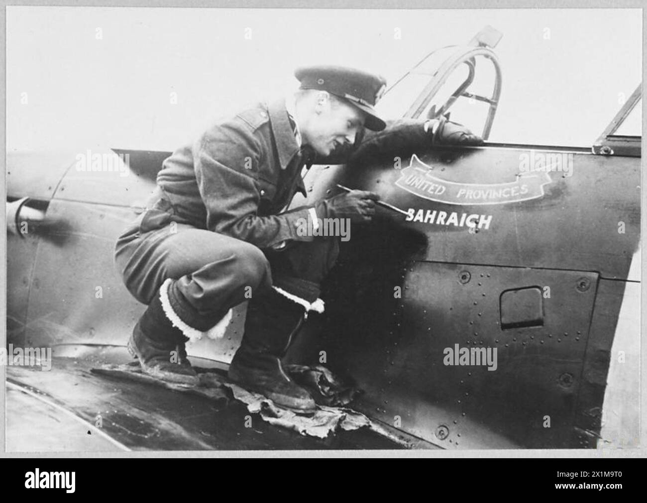 Pilot Officer Mieczysław Gorzula of No. 87 Fighter Squadron RAF paints ...