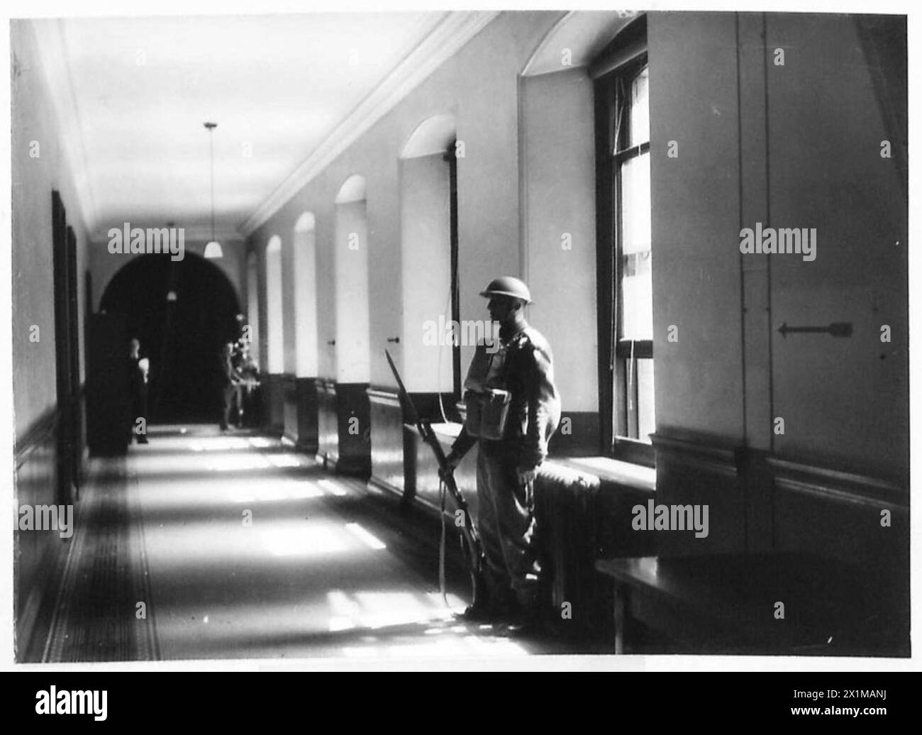 A Grenadier Guard is on duty in a corridor of the War Office ...